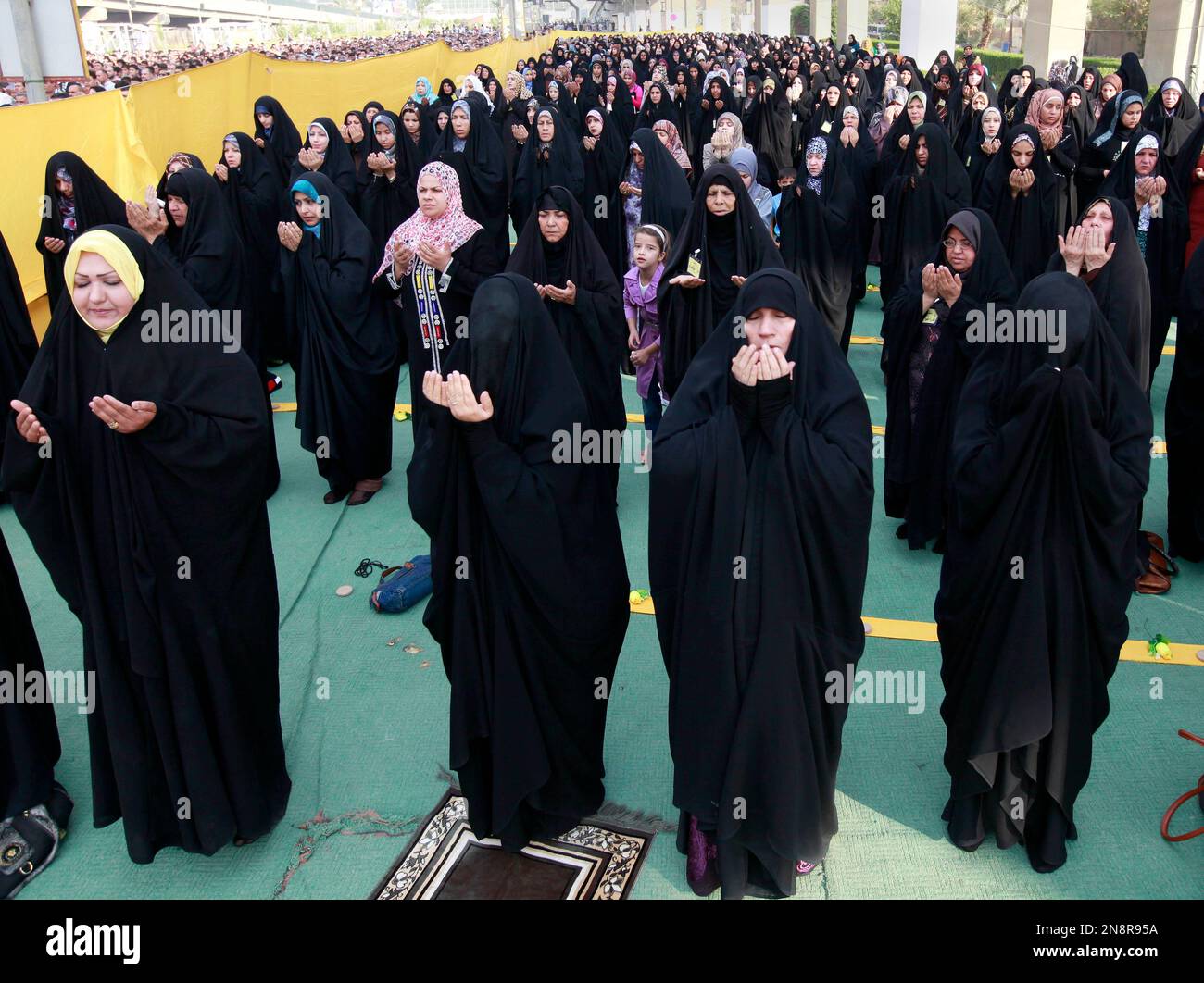 Iraqi Shiite Muslim women attend the Eid al-Adha prayer, outside the ...