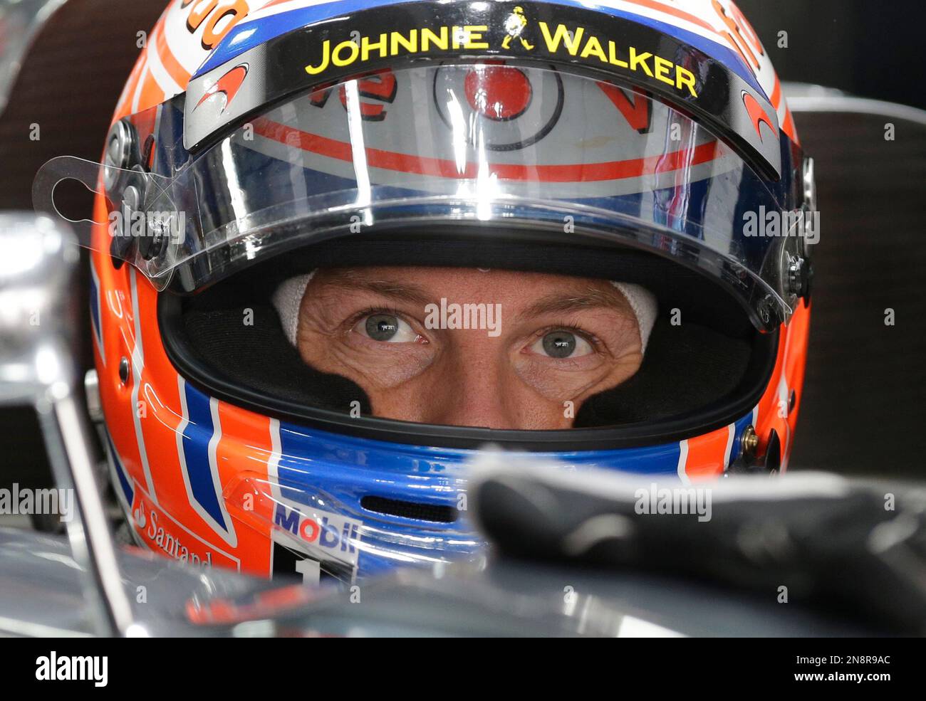 McLaren driver Jenson Button of Britain waits in his car during the ...