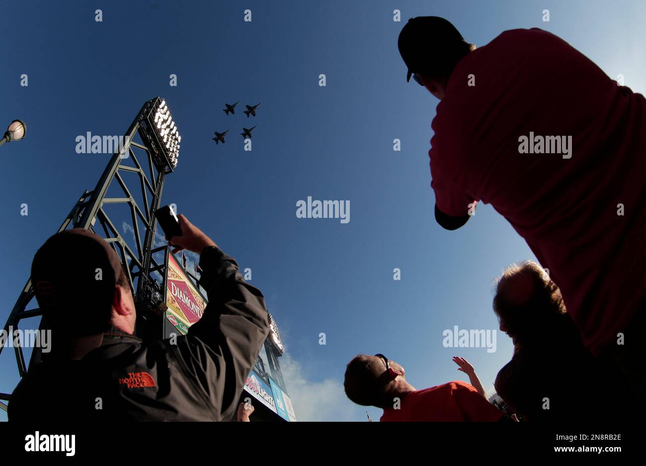 Fans take pictures as the military jets fly over before Game 2 of ...