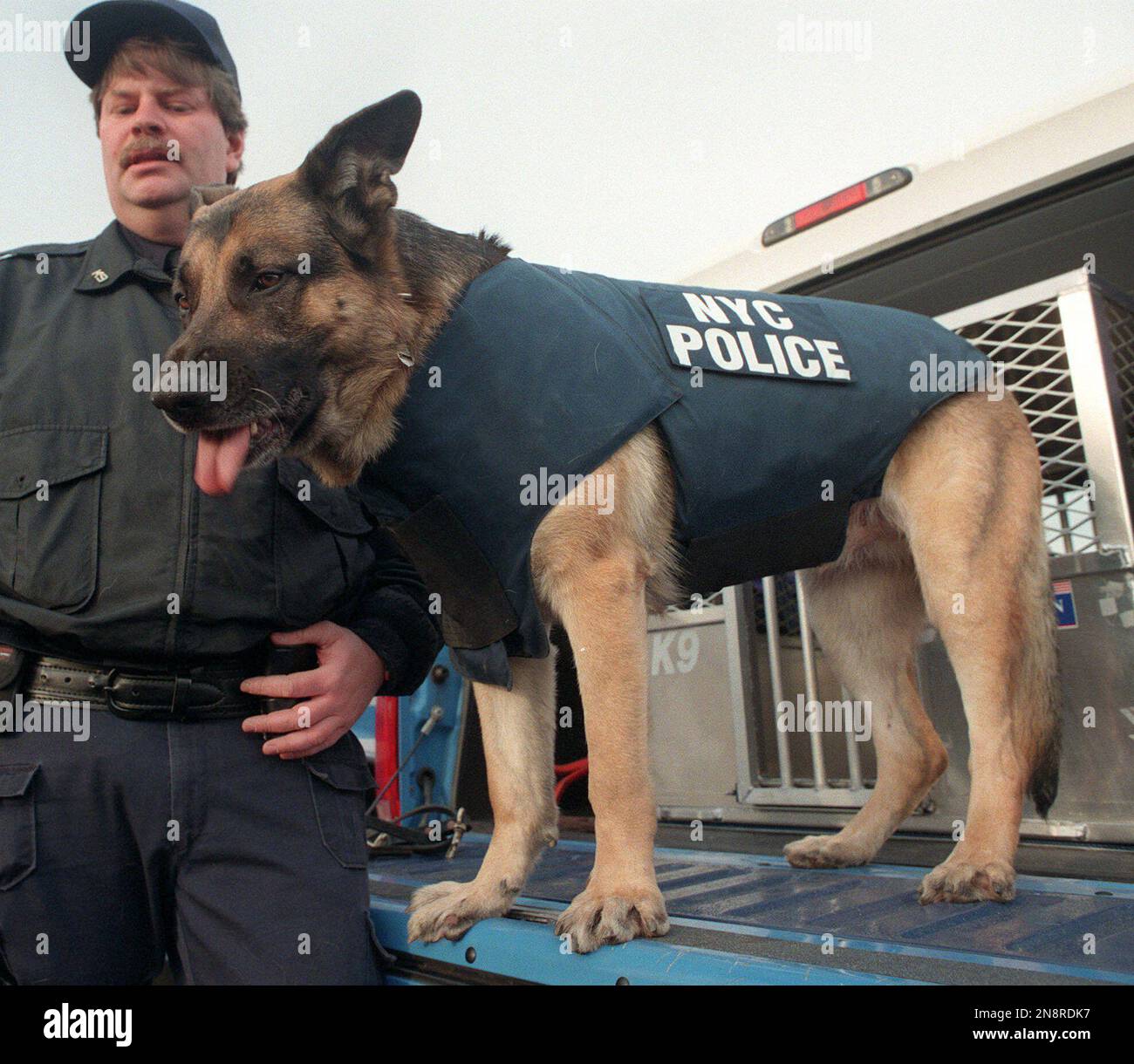 FILE- U.S. Police officer Peter Davis of the NYPD K-9 unit stands with ...
