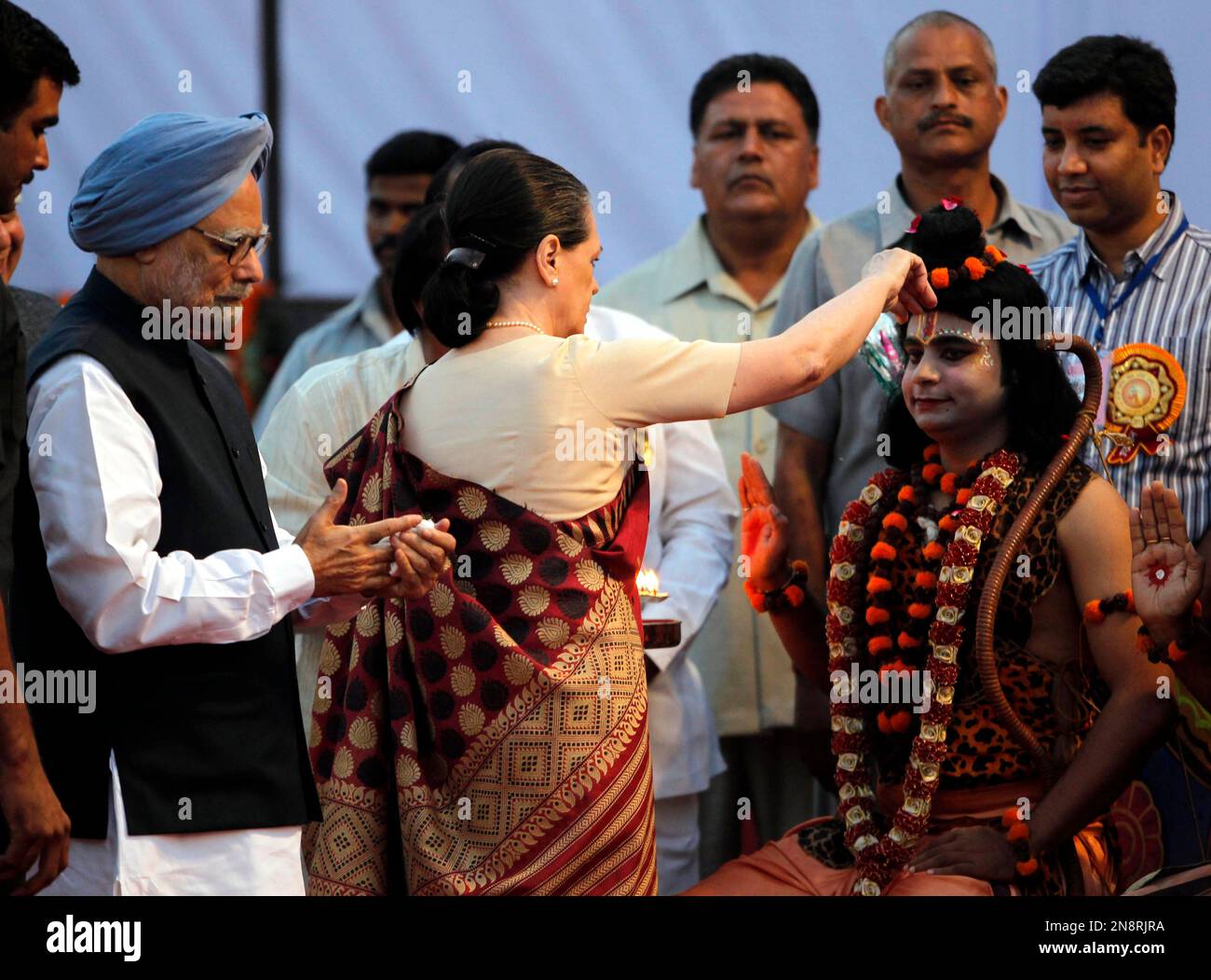 Congress party President Sonia Gandhi, center, performs rituals on a ...