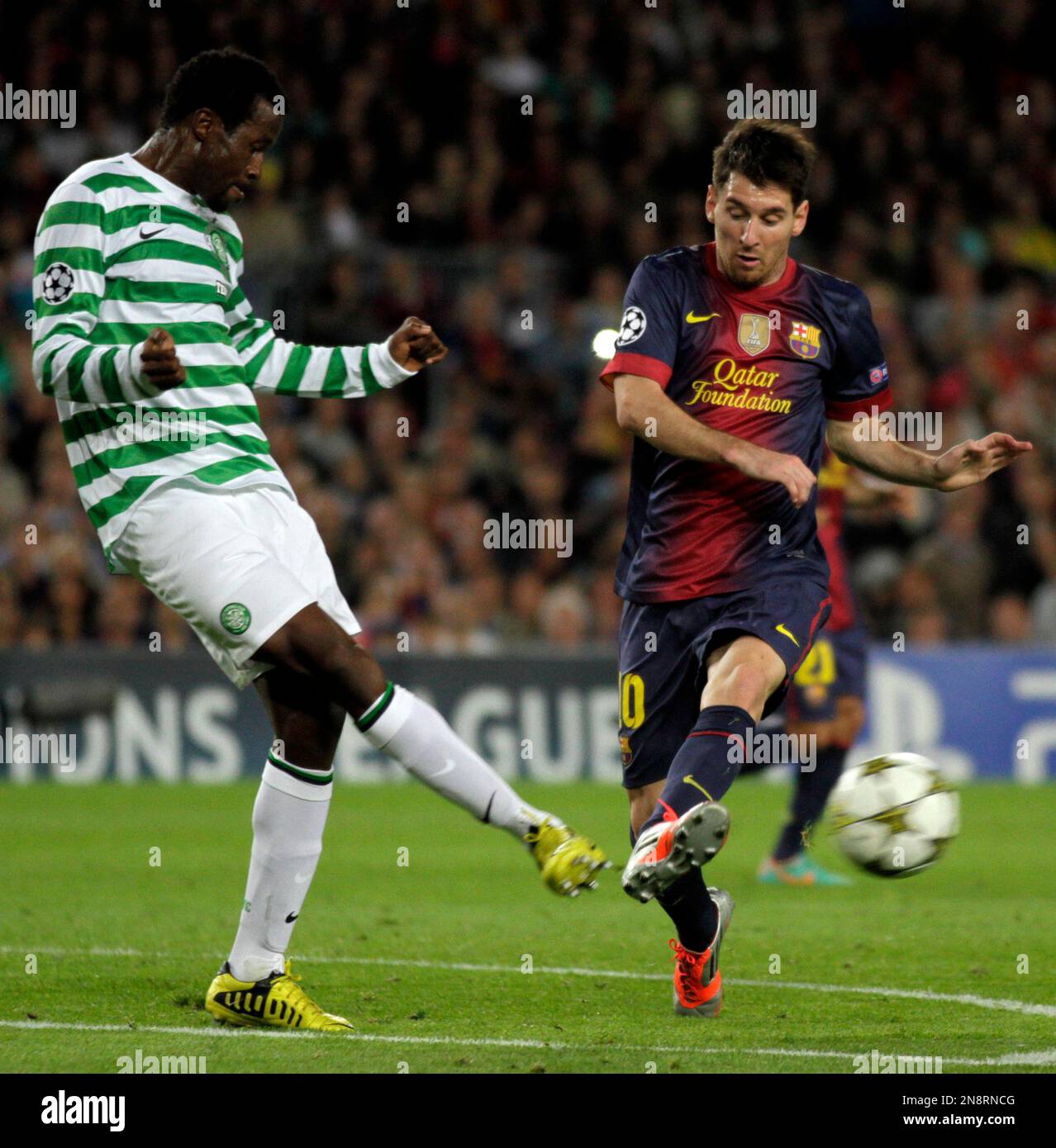Celtic's Efe Ambrose, left, challenges FC Barcelona forward Lionel ...