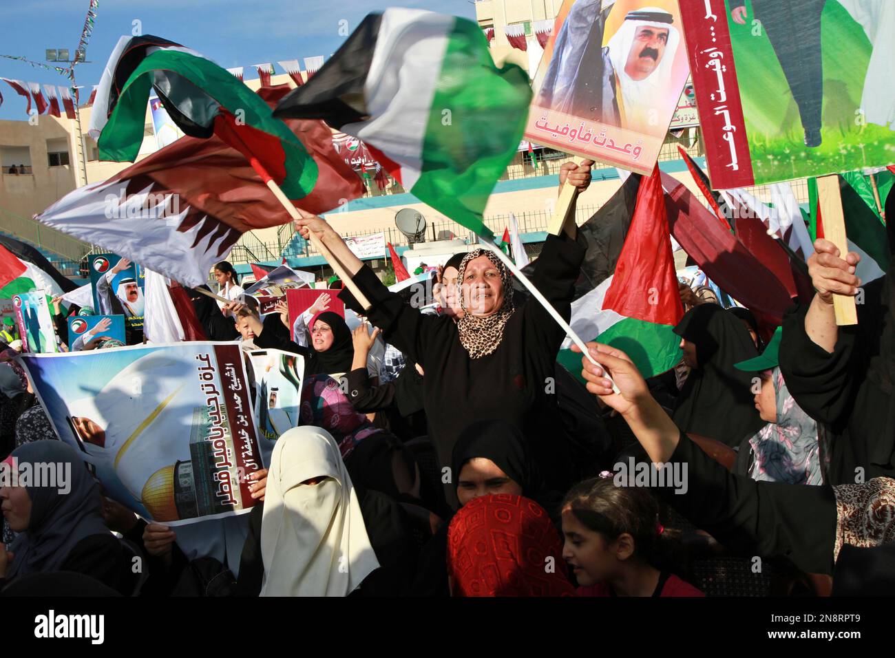 Palestinian Hamas supporter women wave Qatari and Palestinian flags as ...