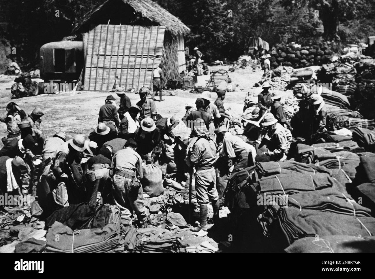 American war prisoners at Bataan, the Philippines, sort U.S. equipment ...
