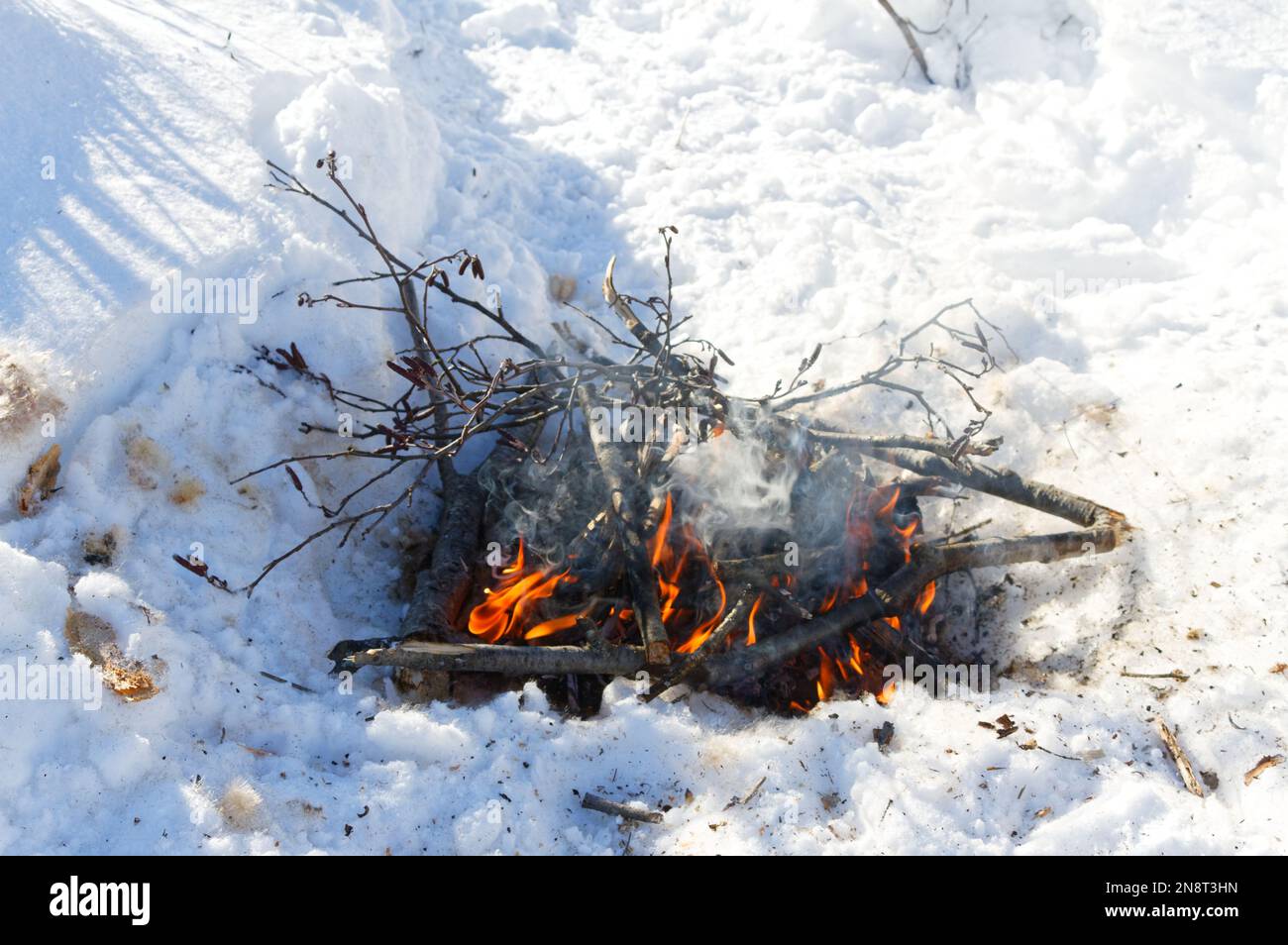 Small campfire in the snow. Quebec,Canada Stock Photo - Alamy