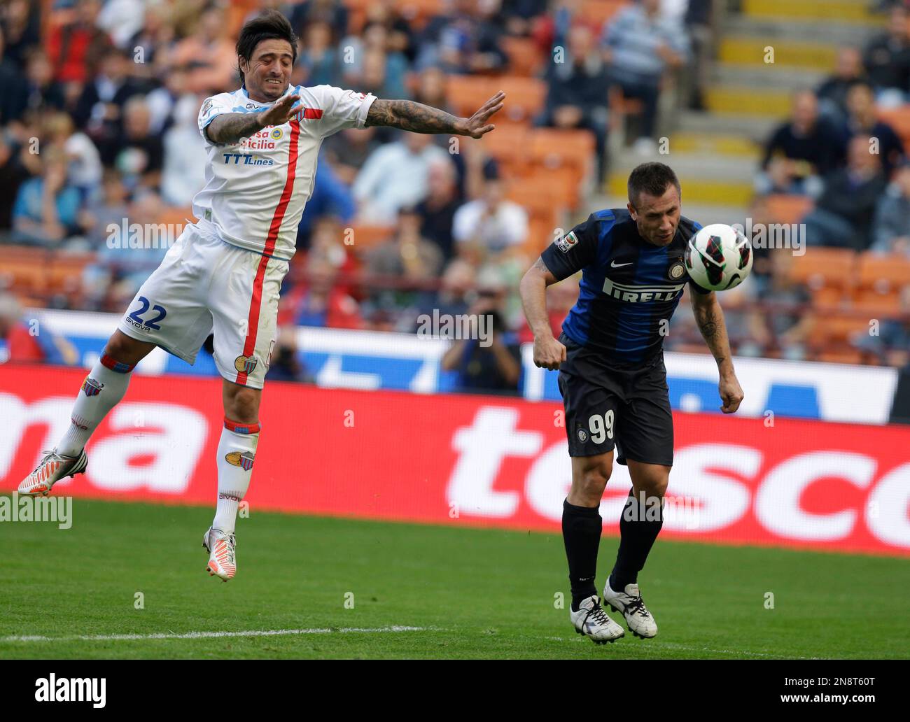 Inter Milan forward Antonio Cassano heads the ball to score as Catania defender Pablo Sebastian ...