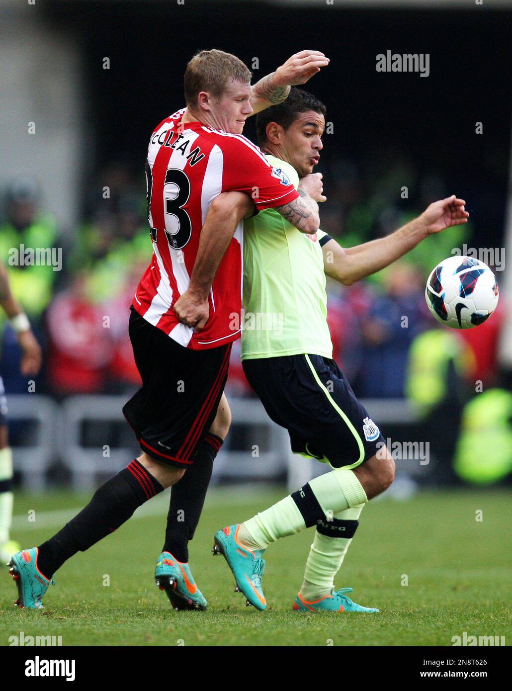 Sunderland's James McClean, left, vies for the ball with Newcastle ...