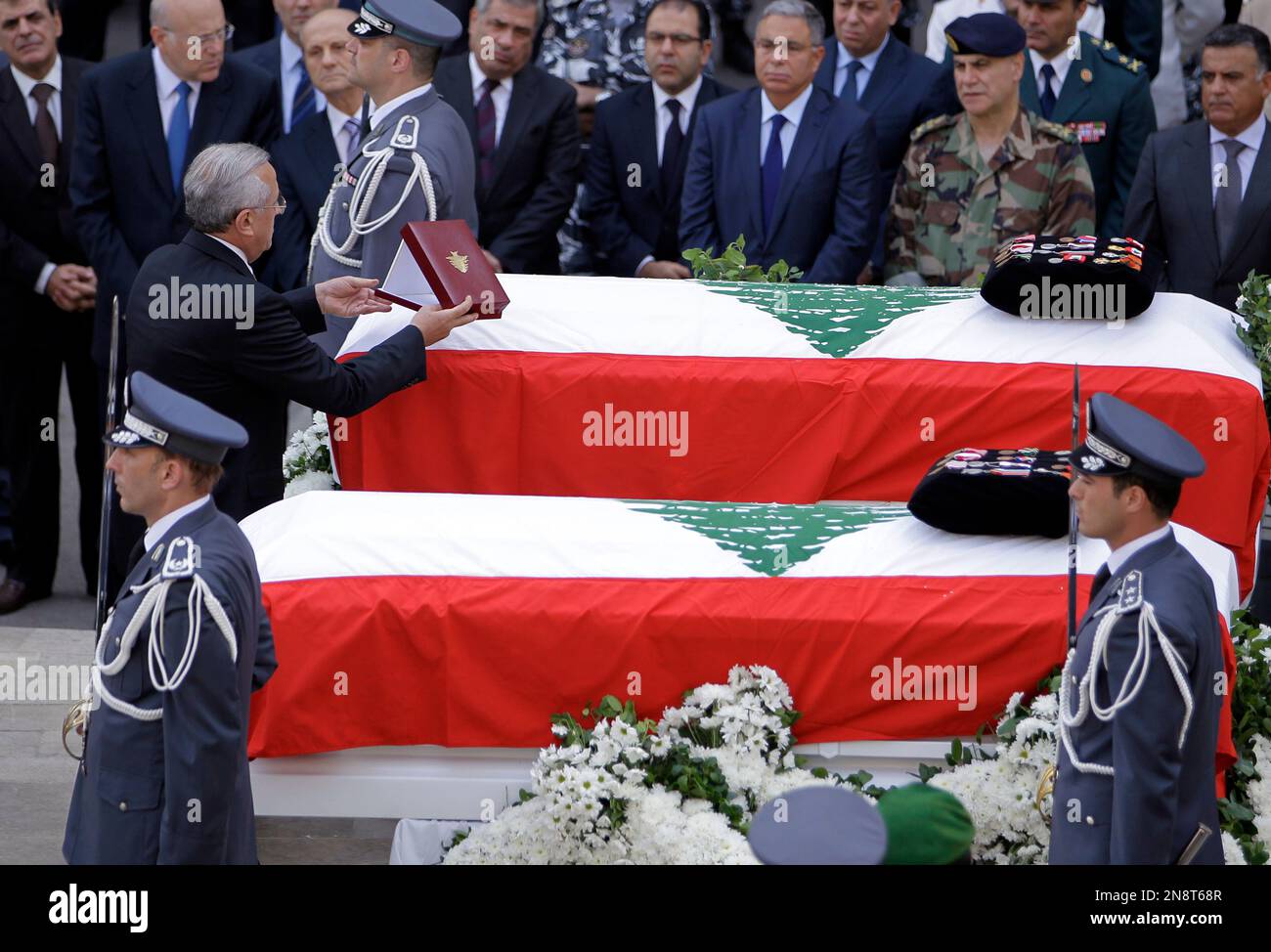 Lebanese President Michel Suleiman, left background, places medals on ...