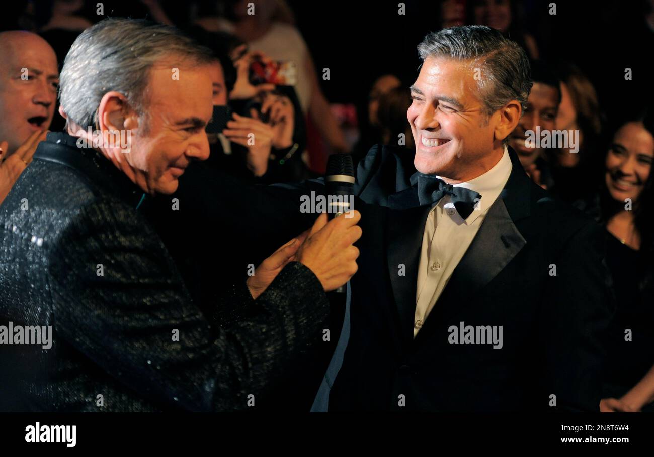 George Clooney, right, shares a laugh with Neil Diamond after singing ...