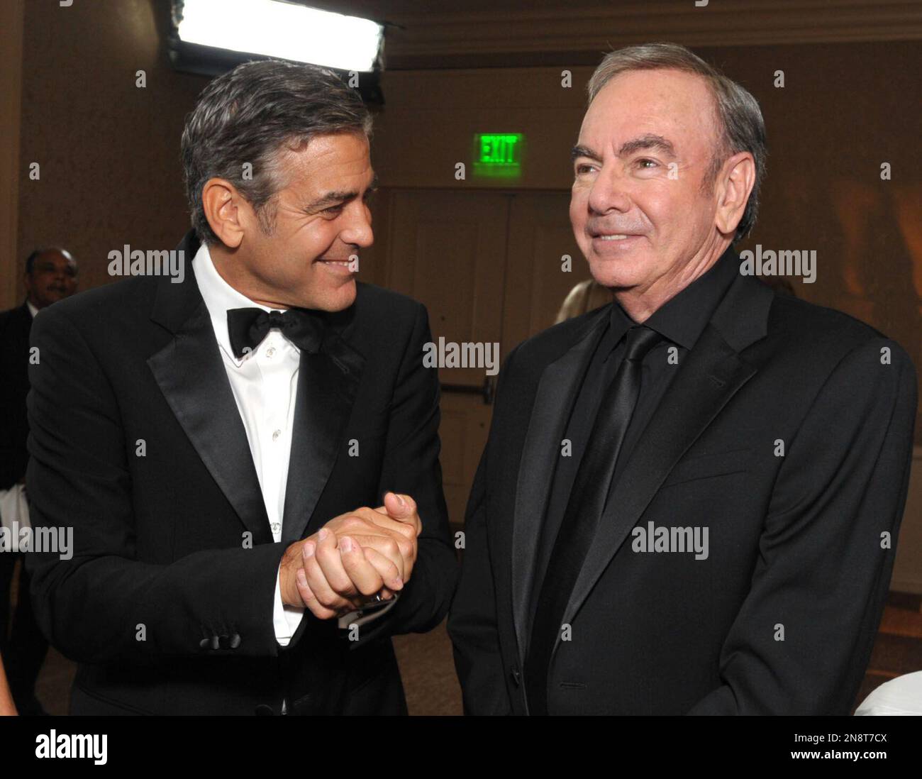 George Clooney, left, and Neil Diamond attend The Carousel of Hope at ...