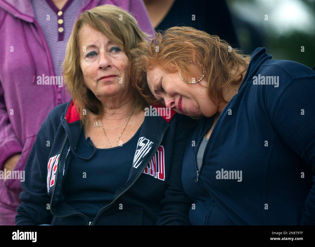 Bonnie Hoisington, left, and Claire Bruyere comfort each other during a ...