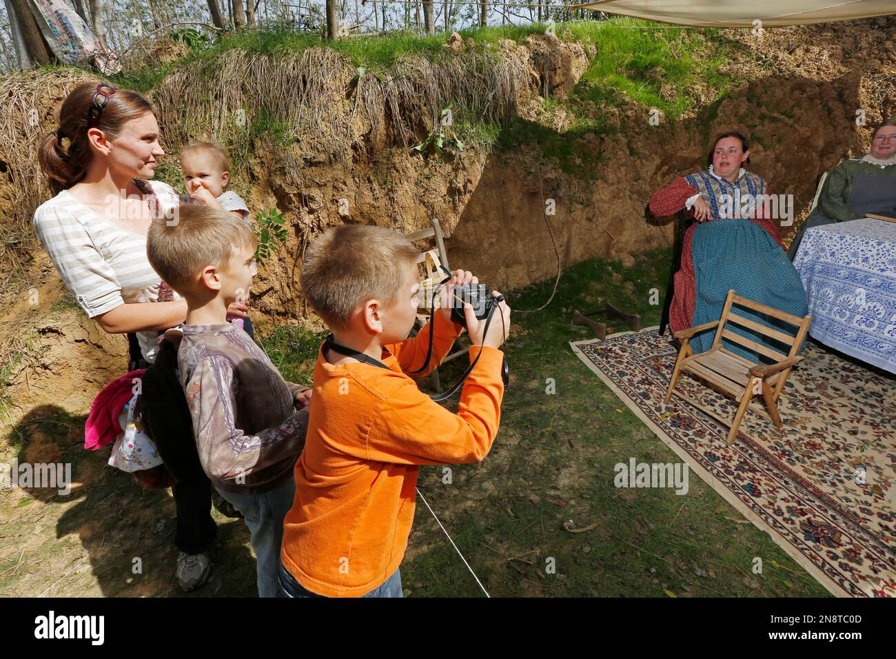 Leslie Gipson holds her daughter Sarah, one, while brothers Benjamin ...