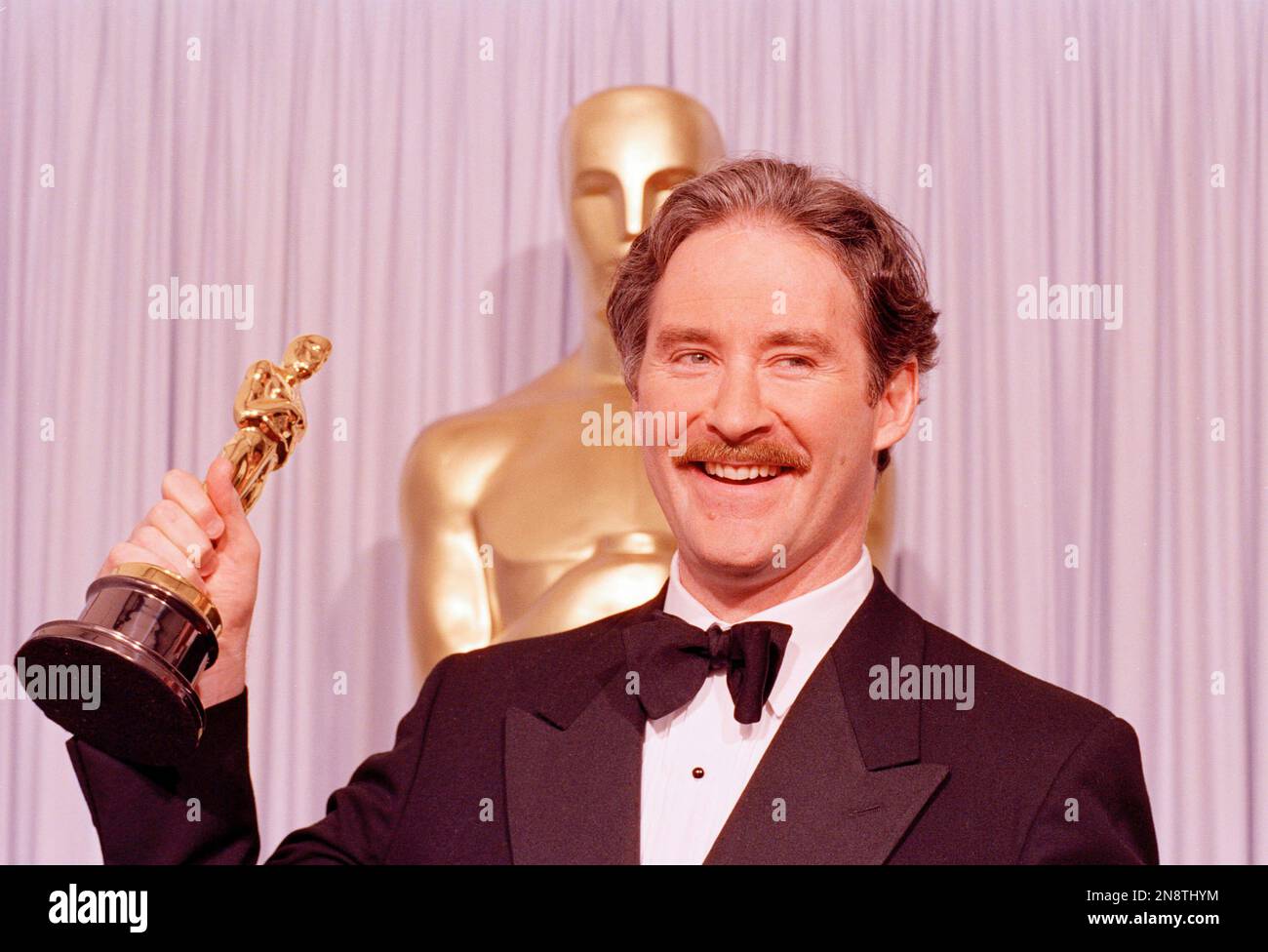 Actor Kevin Kline is seen with the Academy Award he won as best ...
