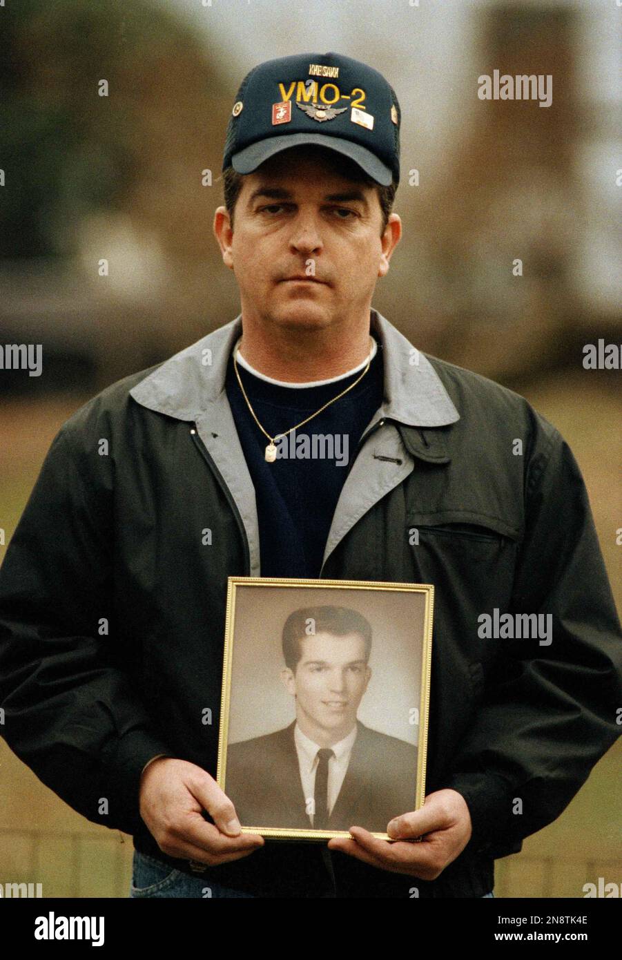 Holding his high school senior picture, retired U.S. Marine, Gary ...