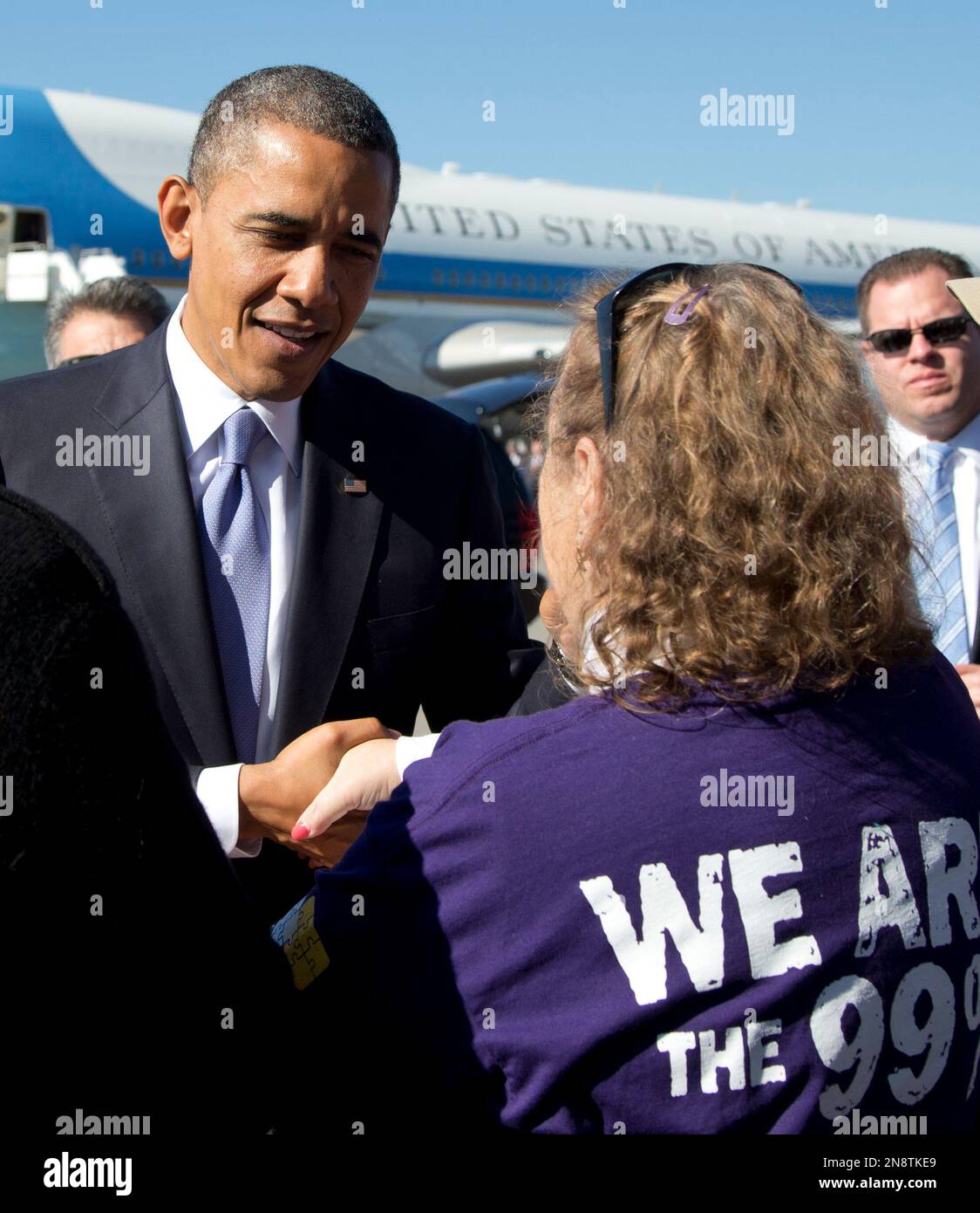 President Barack Obama greets people as he arrives at Manchester Boston ...