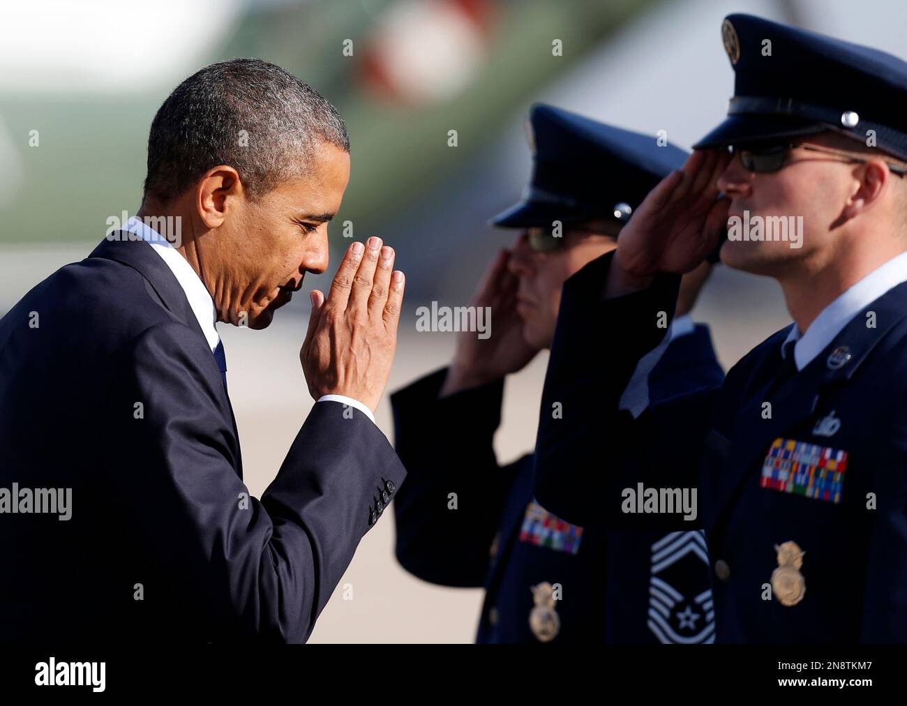President Barack Obama returns a salute as he boards Air Force One at ...