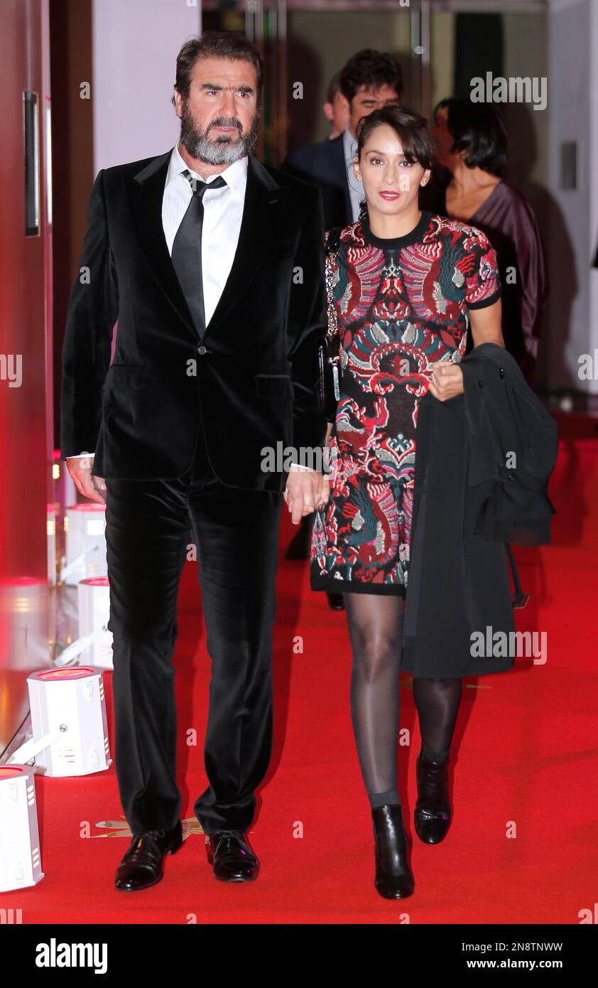 French former soccer player Eric Cantona arrives with his wife Rachida ...