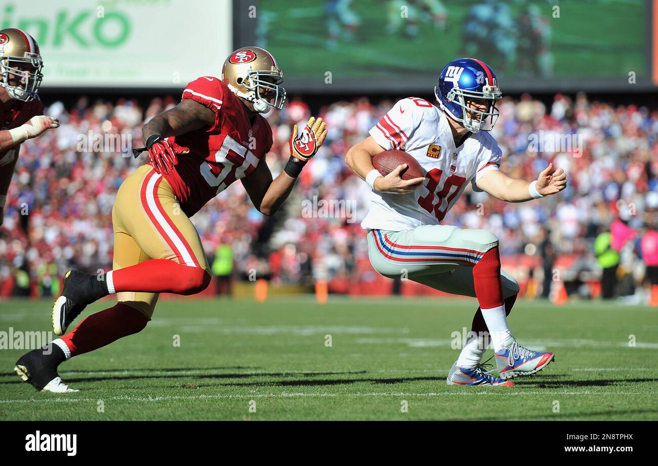 New York Giants quarterback Eli Manning (10) runs from San Francisco ...
