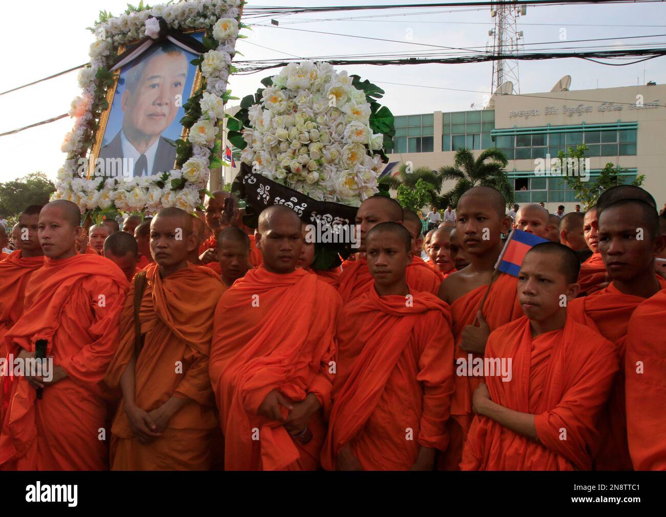 Cambodian Buddhist monks watch the casket carrying the body of Cambodia ...