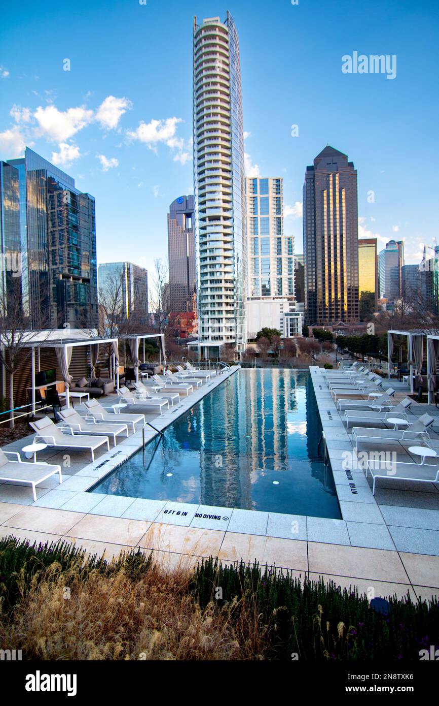 A vertical shot of residential buildings reflecting on a pool in ...