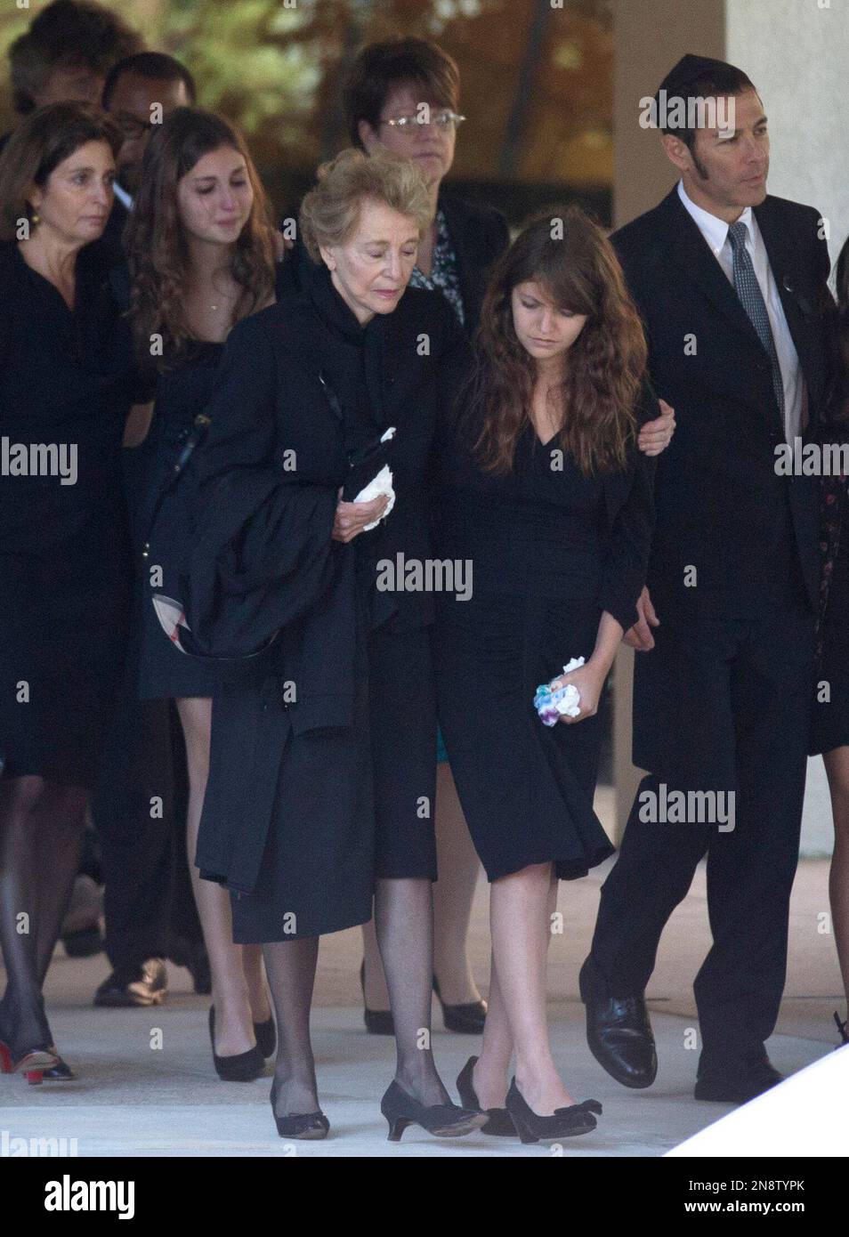 Joan Specter, third from left, and others leaves Har Zion Temple after ...
