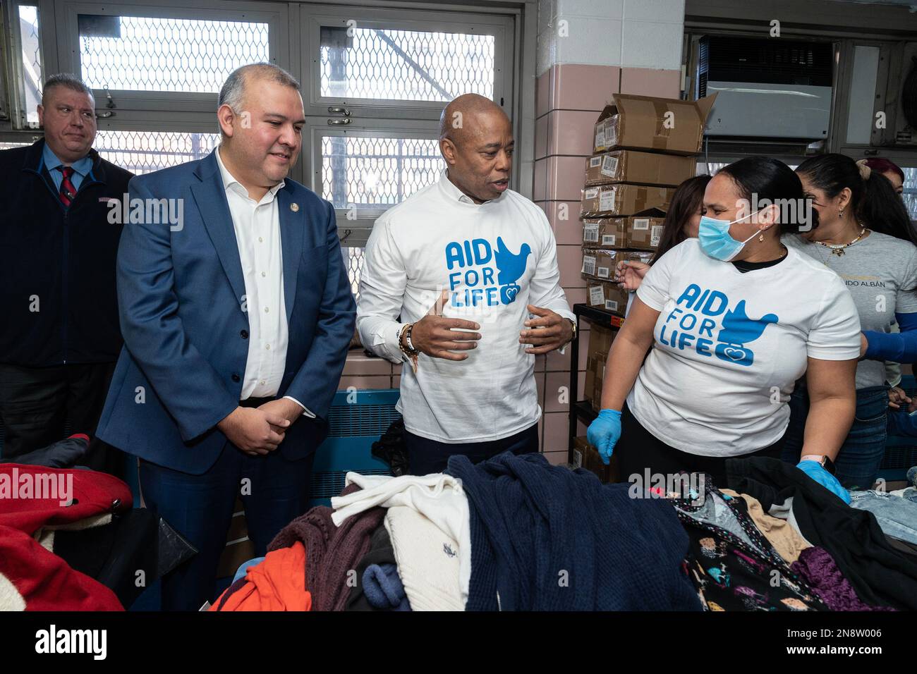 Mayor Eric Adams helps distribute donated food and clothing to families ...