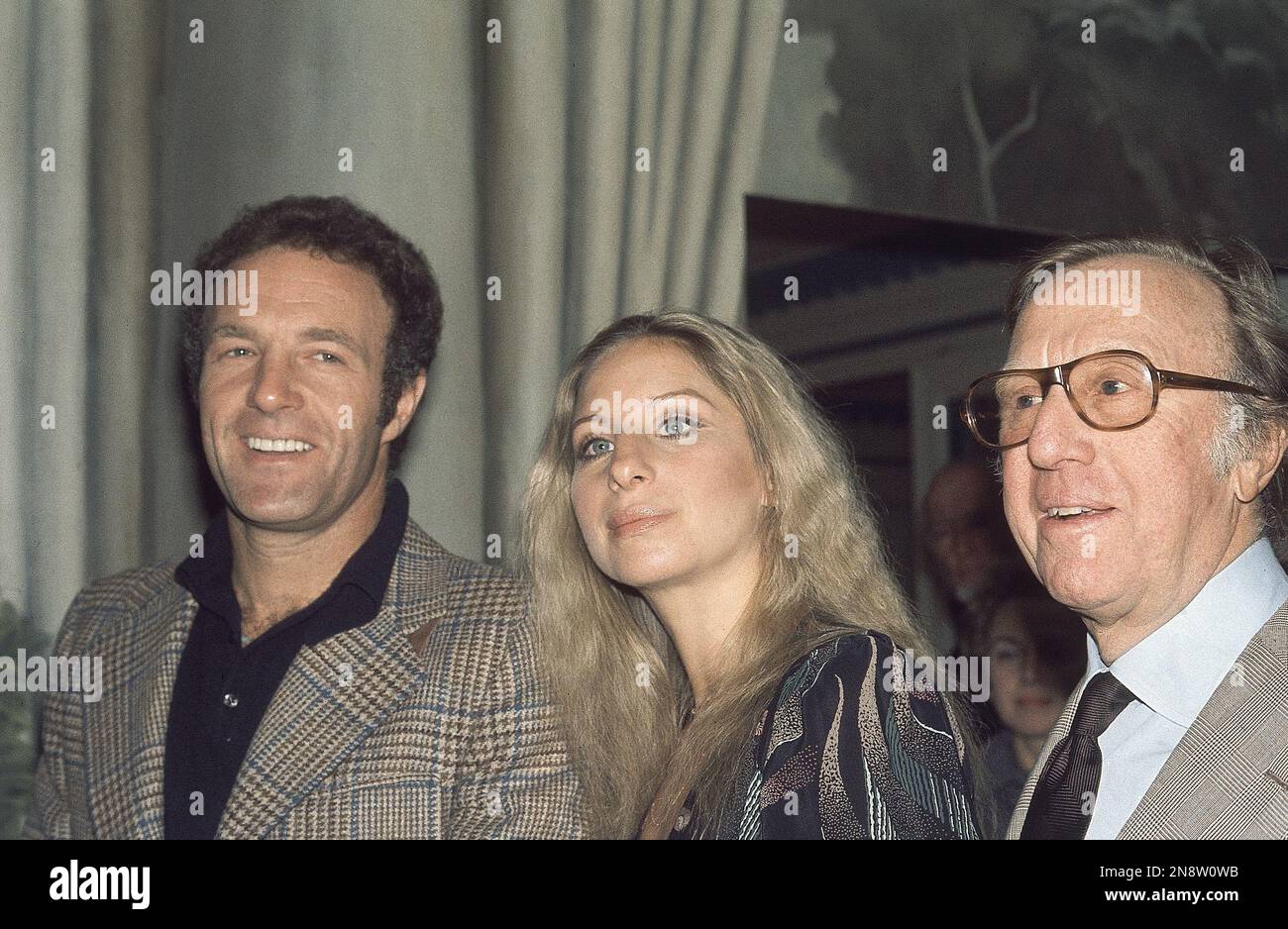 Singer and actress Barbra Streisand is flanked by actor James Caan ...