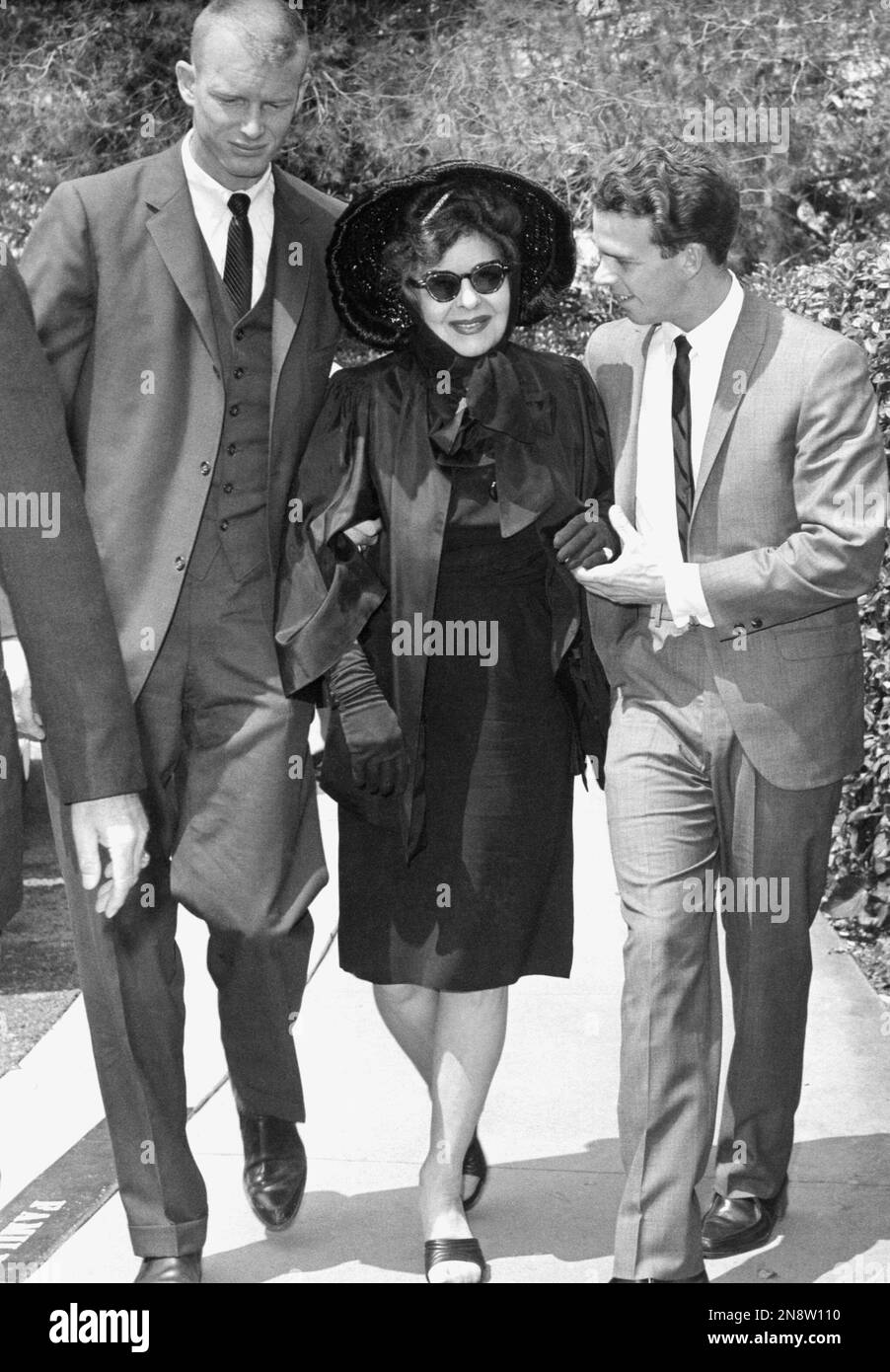 Former actress Clara Bow is aided by her sons Tony, left, and George ...