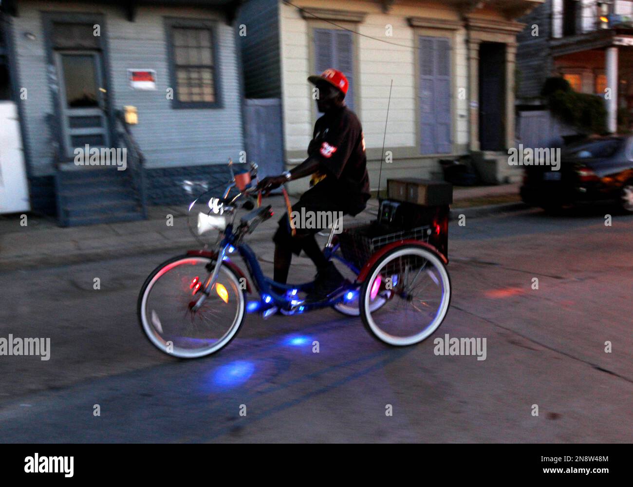 In this Oct. 11, 2012 photo, a man rides a bicycle adorned with lights ...