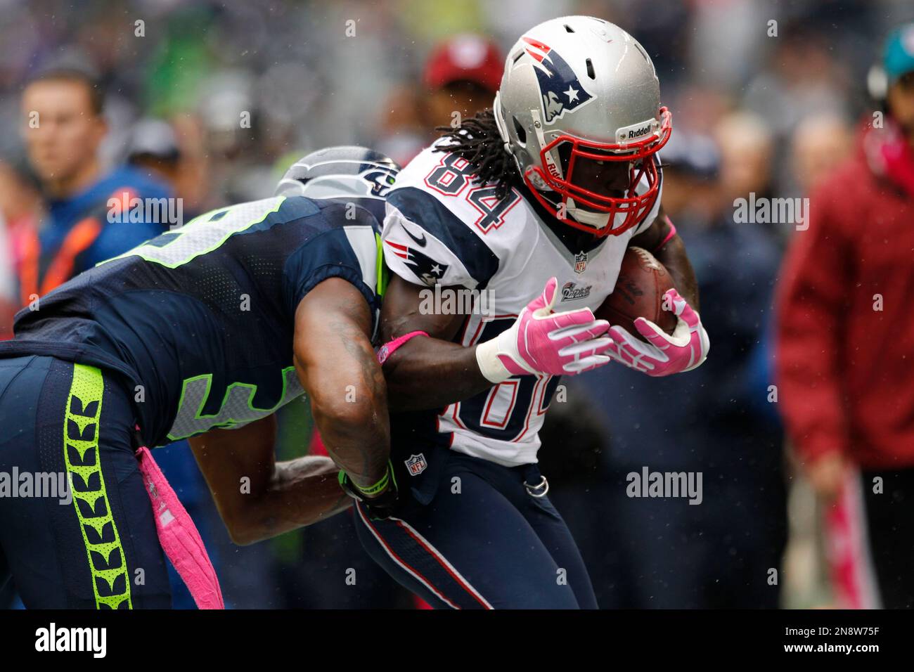 New England Patriots' Deion Branch i(84) is tackled by Seattle Seahawks ...