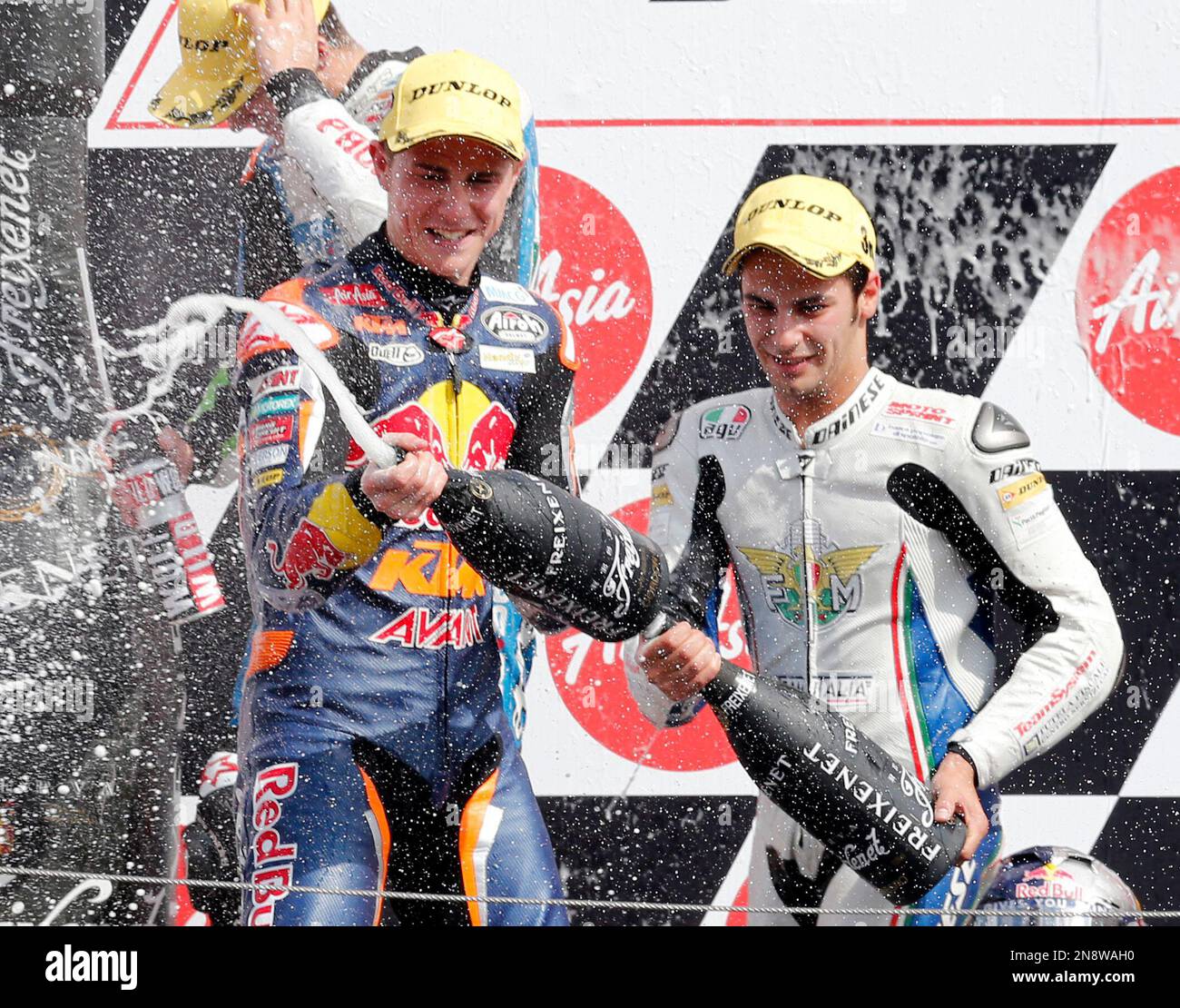 Britain's Danny Kent, left, celebrates with third placed Alessandro ...