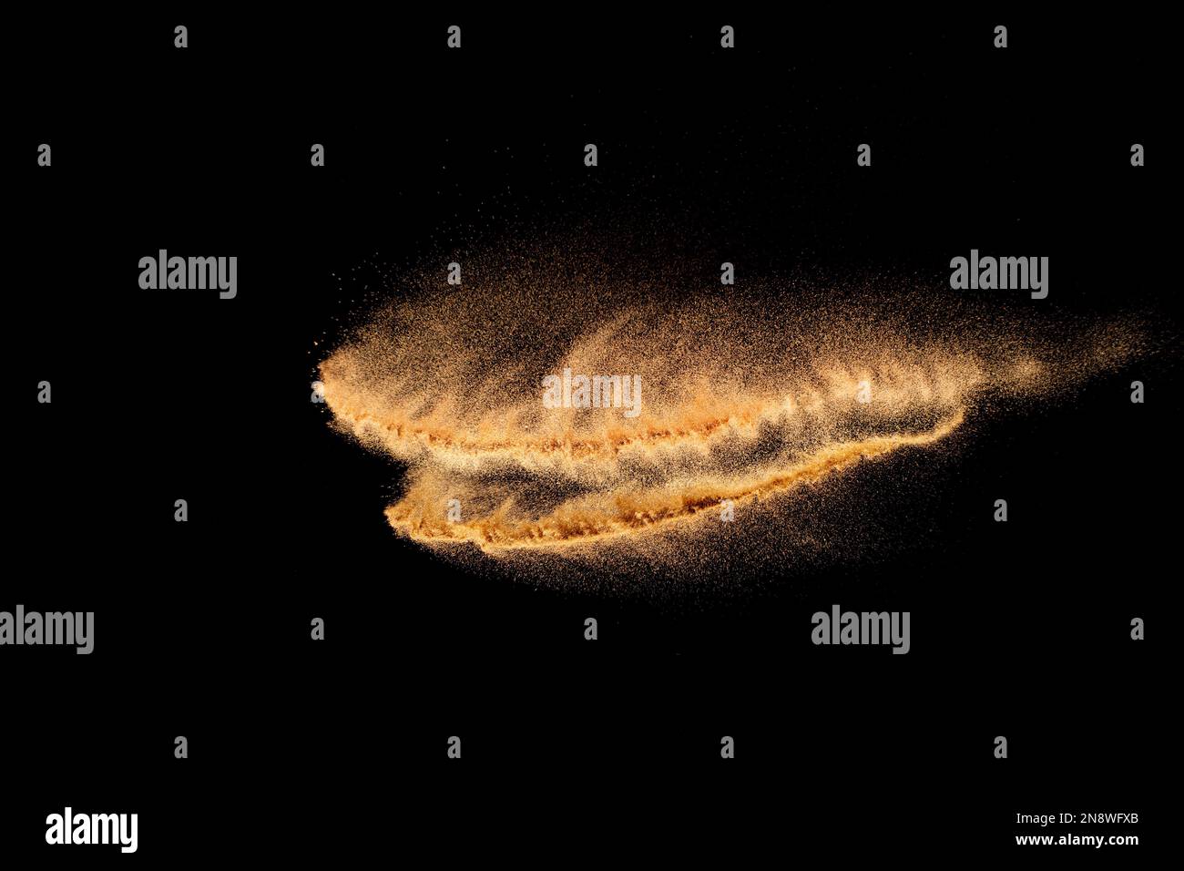 Brown color sand splash against black background. Sand fly wave in the ...
