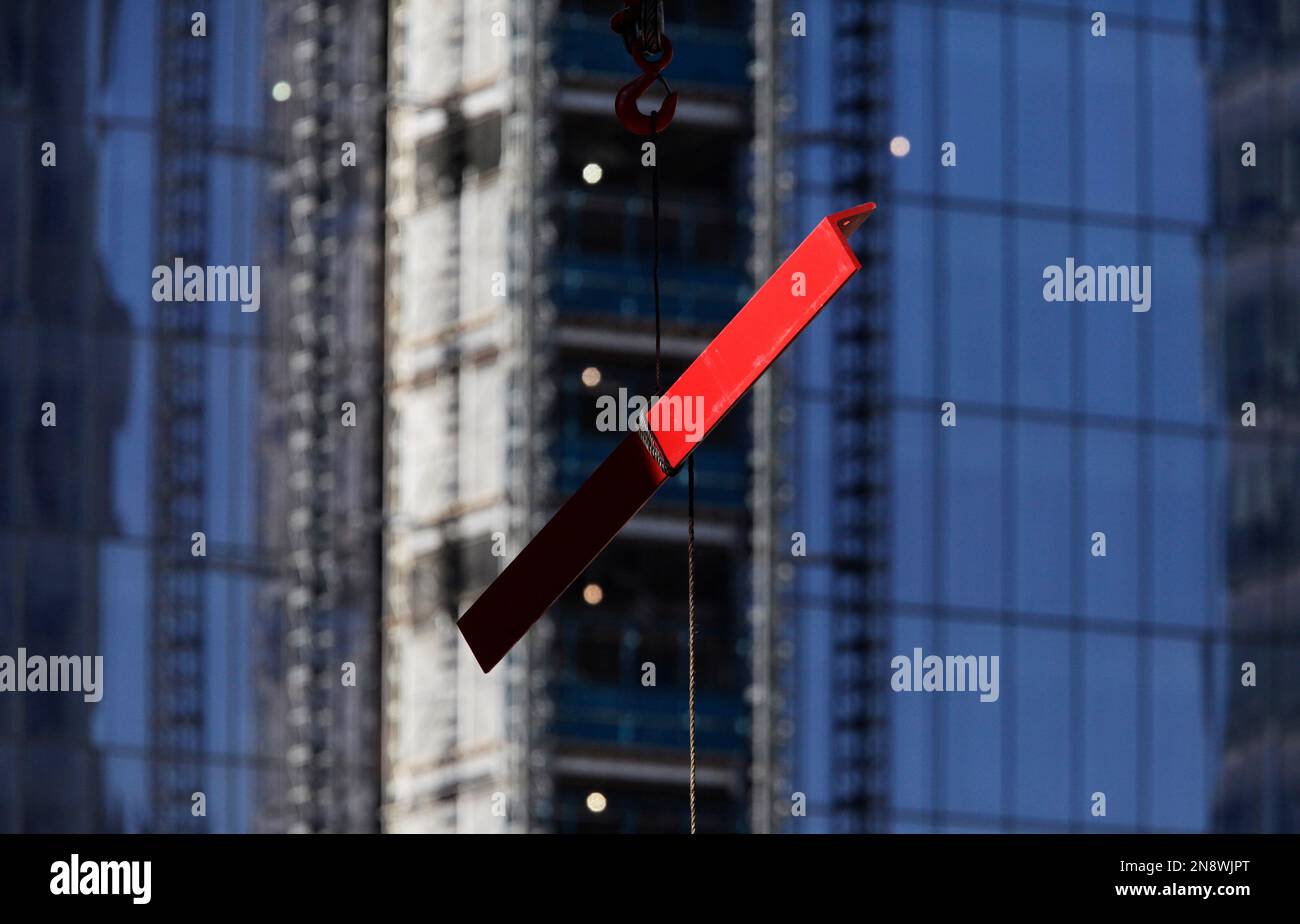 In this photo of Thursday, Oct. 11, 2012, a steel beam is hoisted by ...