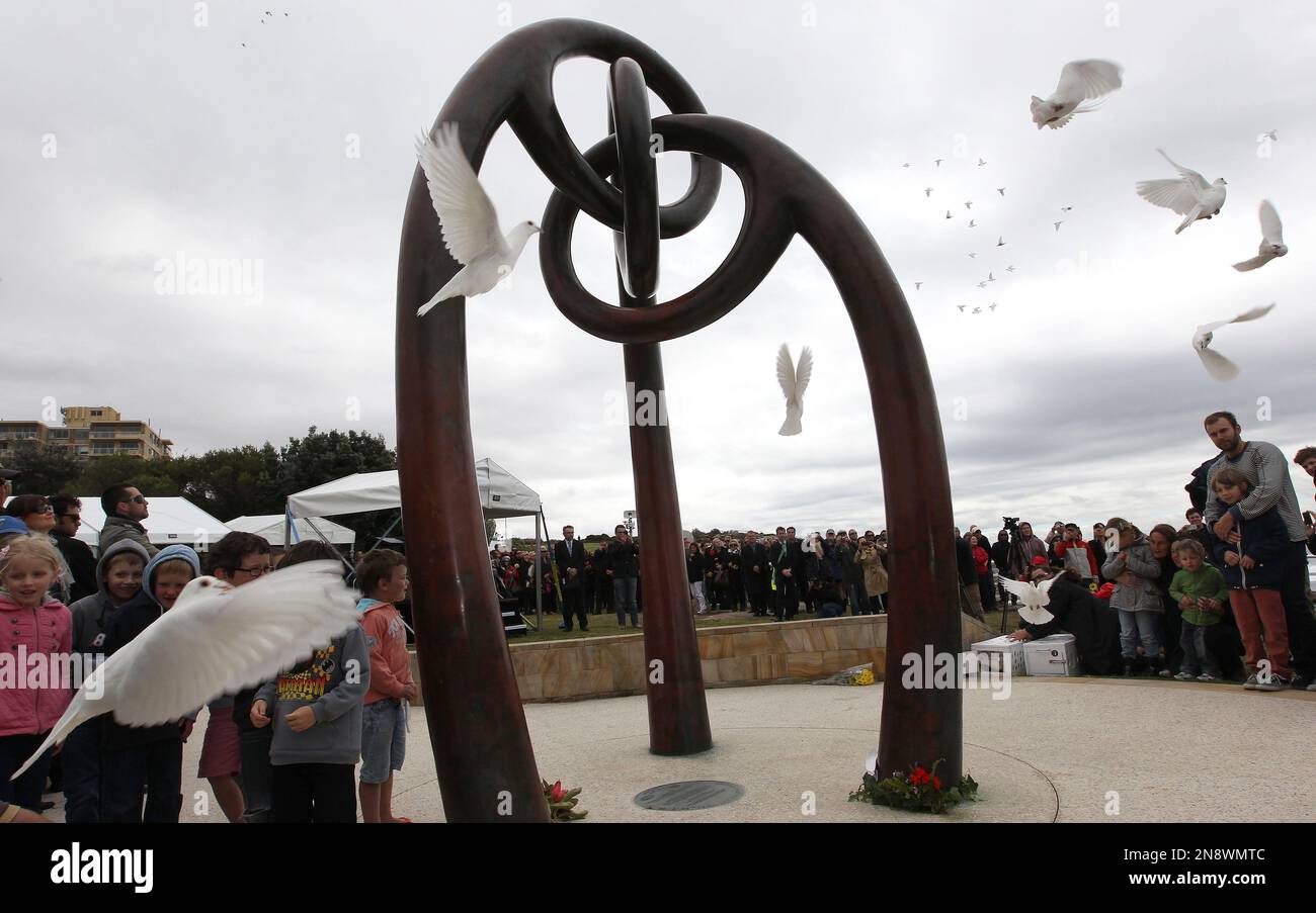 People watch 88 white peace doves being released at Dolphin Point in ...