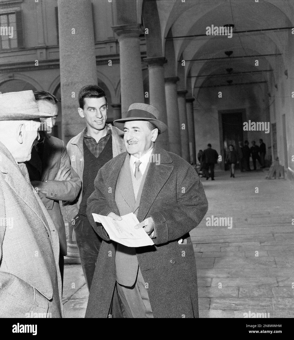 Italian poet and writer Salvatore Quasimodo holds a bunch of ...