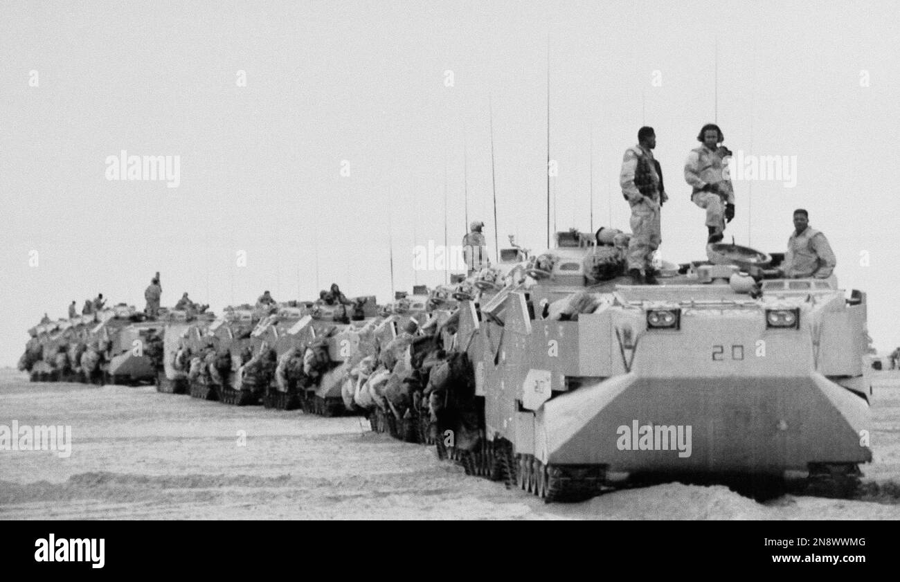 A column of U.S. Marine Amtrack amphibious tracked vehicles lines up at ...