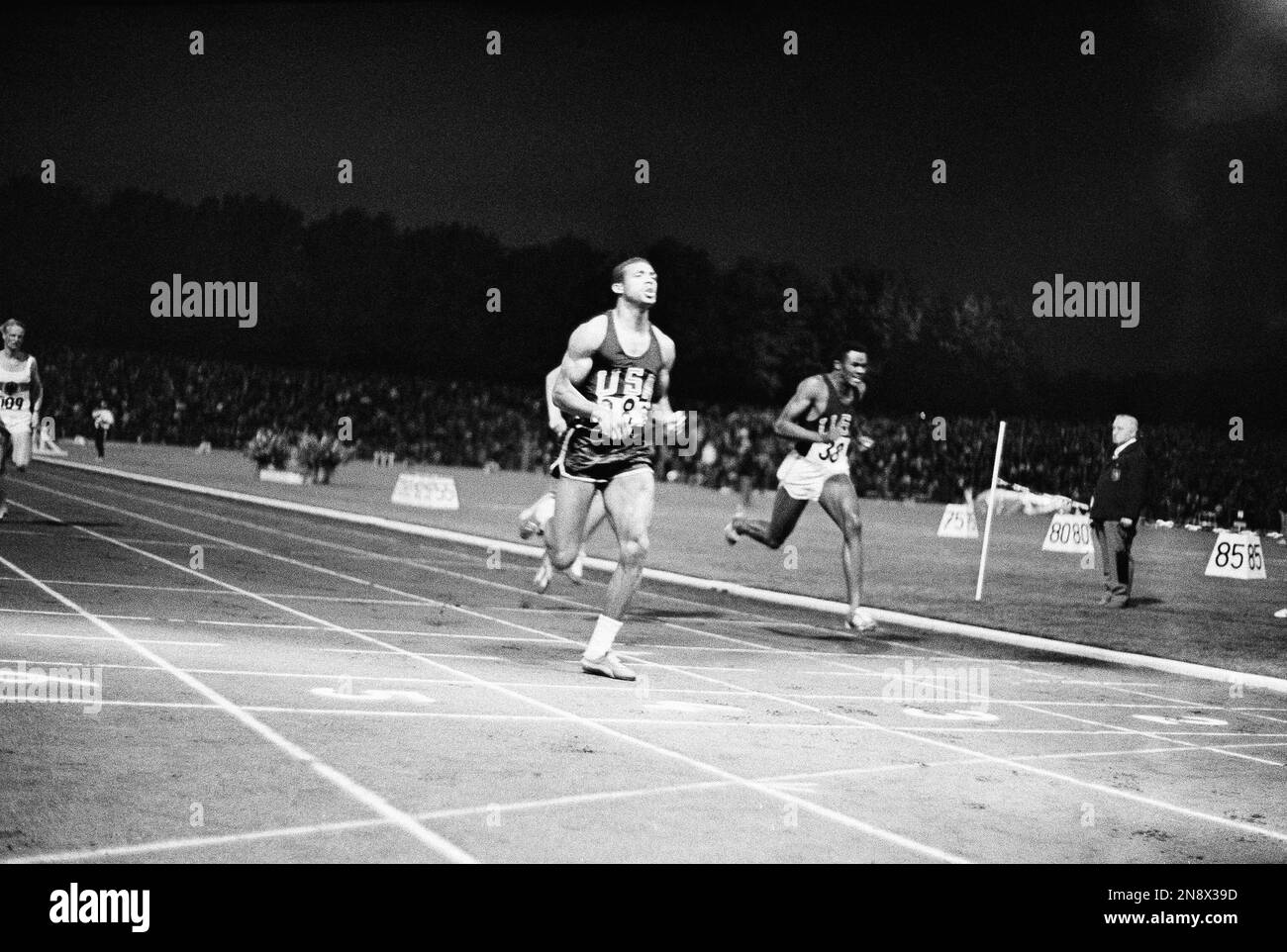 Track and field athlete John Carlos, left, wins the 200m dash of the German-U.S. track meet ...