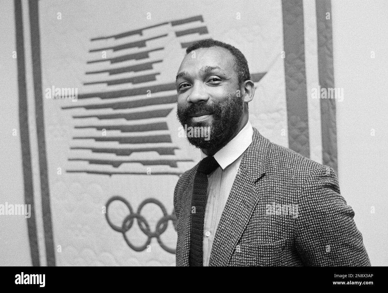 Athlete John Carlos poses in front of the Olympic sign for Los Angeles ...