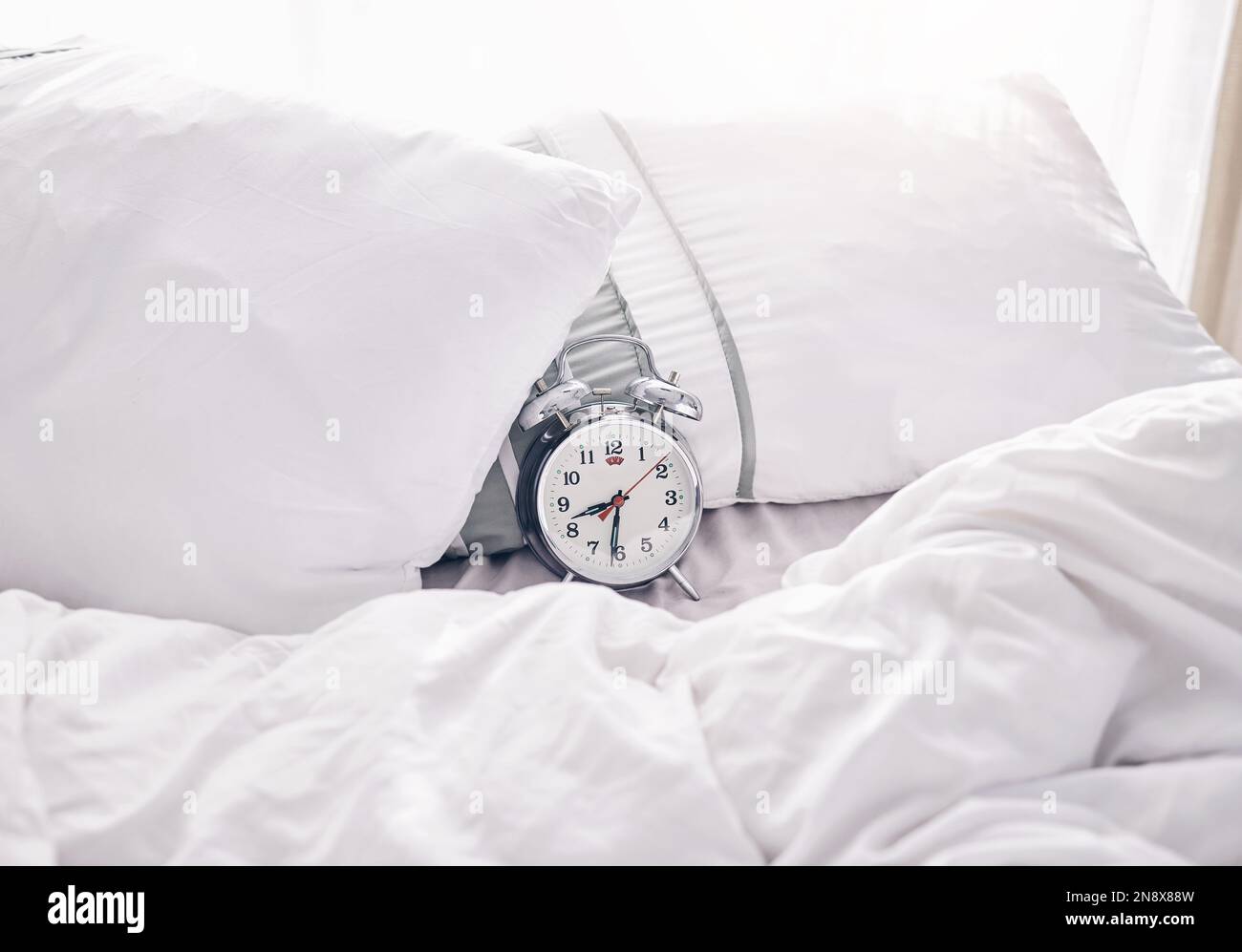 Time, waking up and alarm clock on a bed with no people for punctual ...