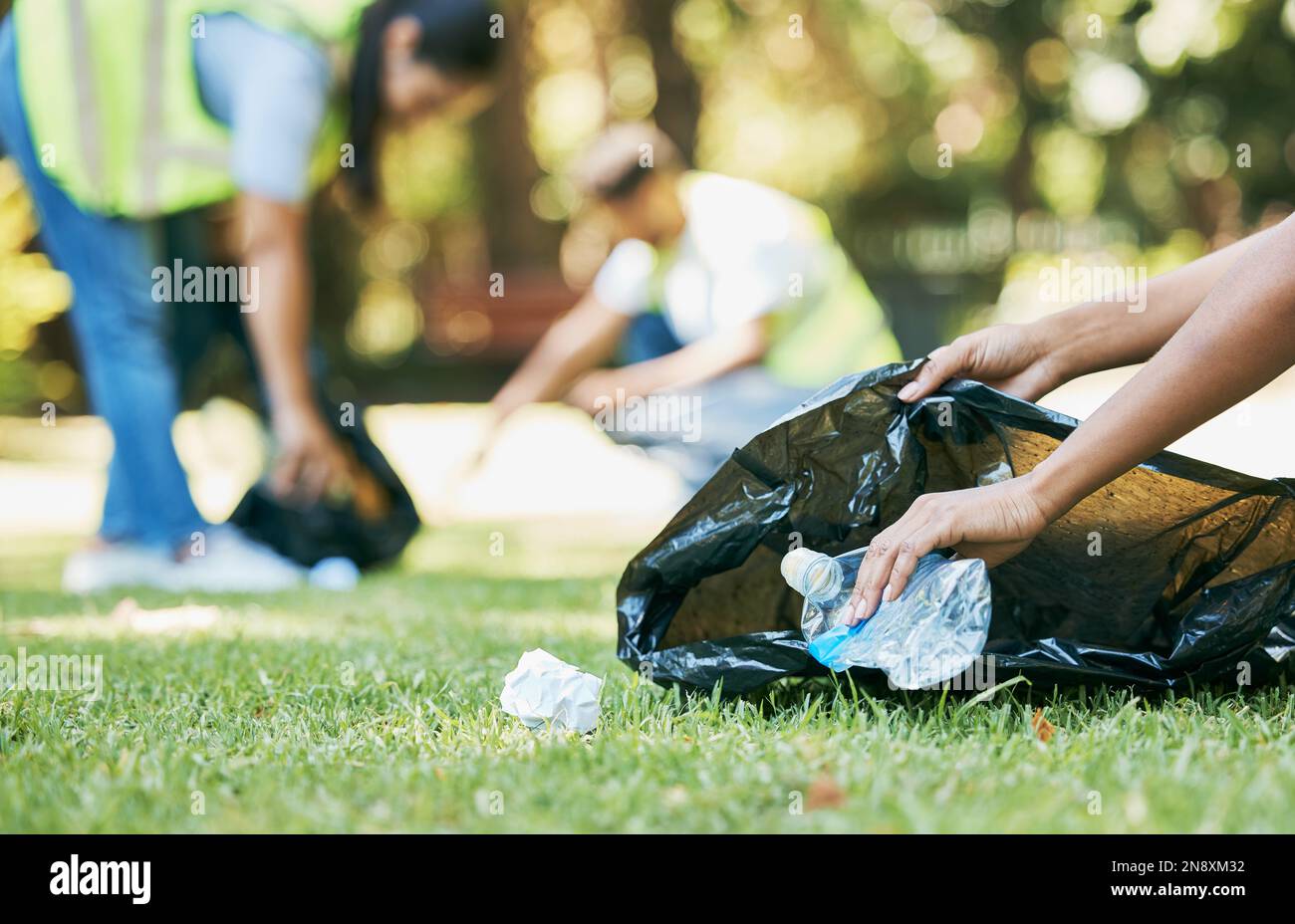 Volunteer hands, cleaning up and trash bag for pollution, carbon ...