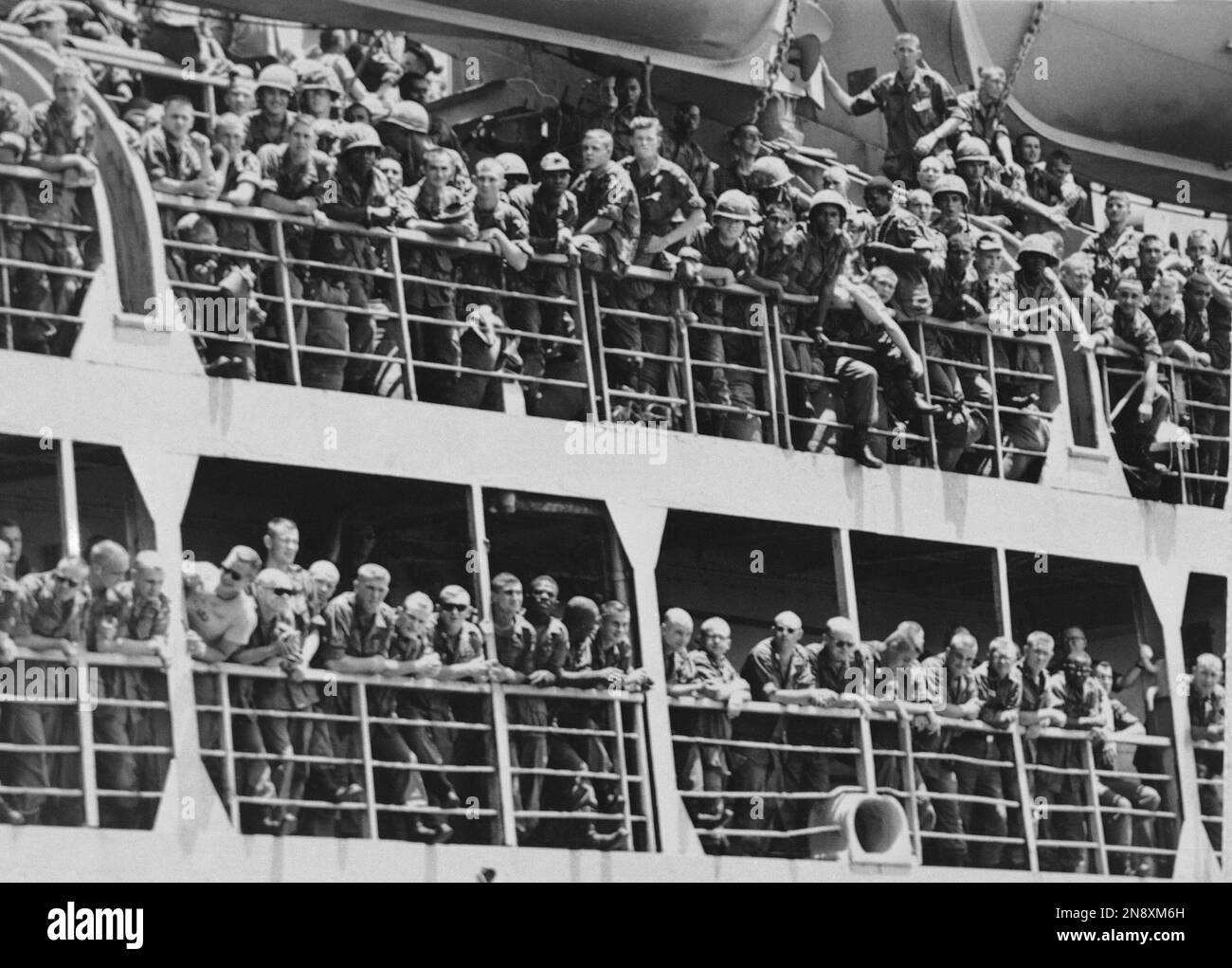 Troopers of first brigade of 101st Airborne division pack the railings ...
