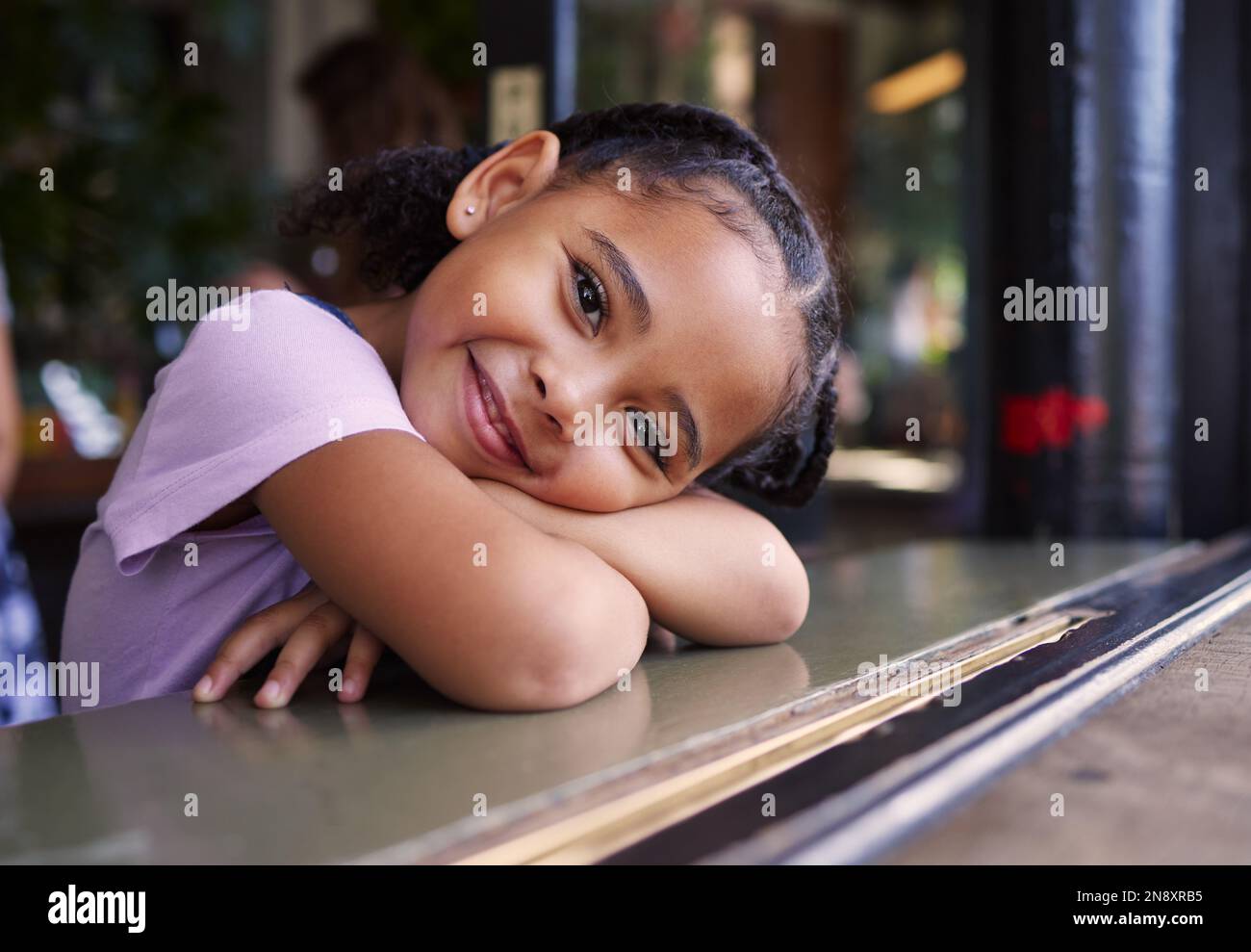 Portrait, cute and adorable girl at a restaurant, cafe and coffee shop ...