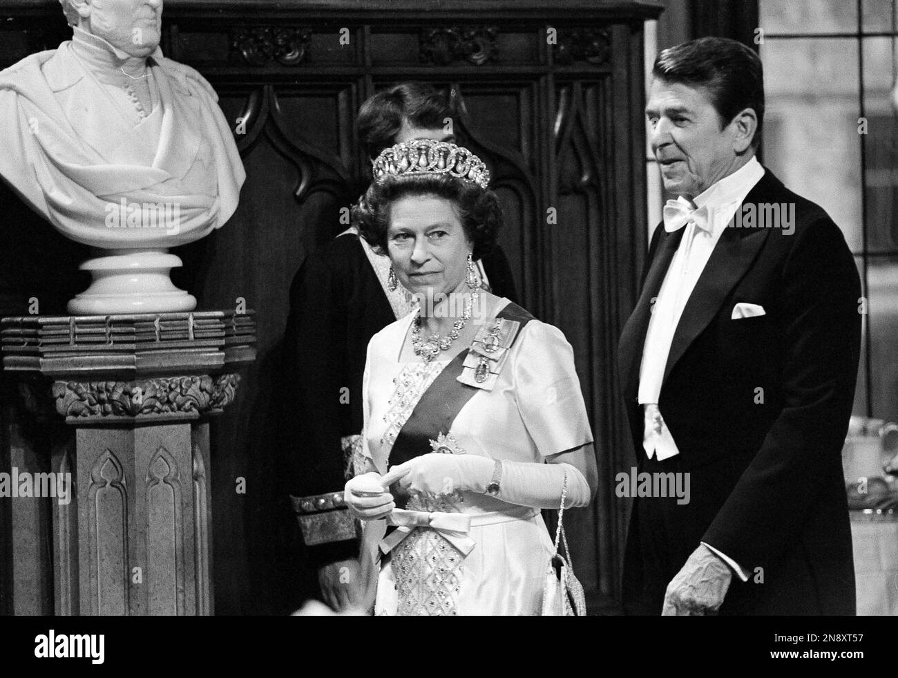 Queen Elizabeth II and President Ronald Reagan walk to the table in the ...