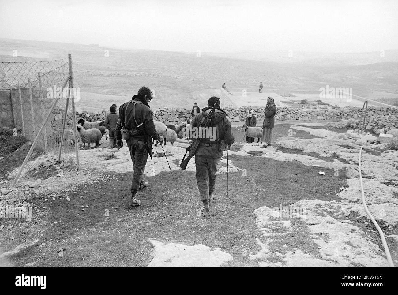 Israeli soldiers probe for possible terrorist mines in a field outside ...