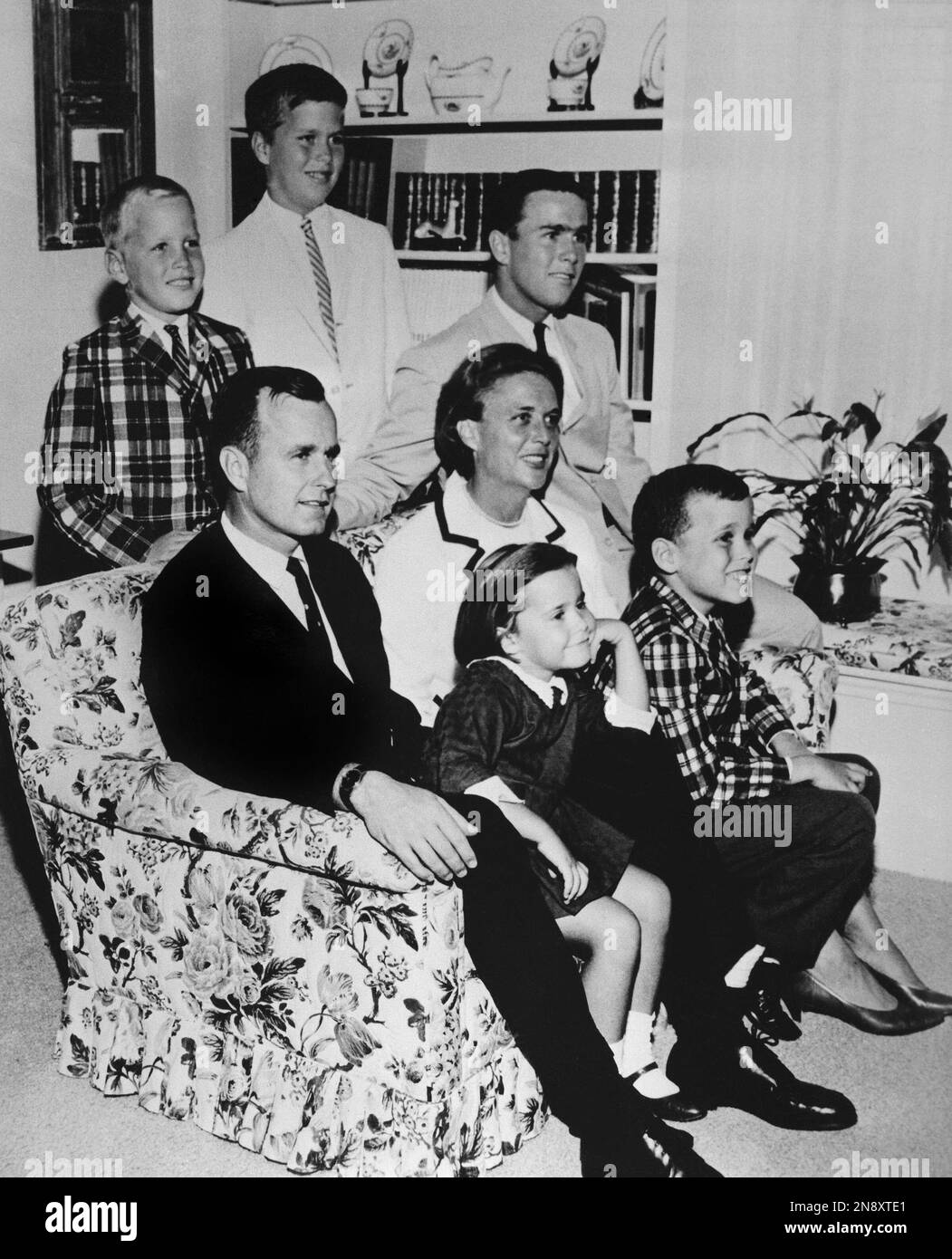 George H.W. Bush sits on the couch with his wife Barbara and their ...