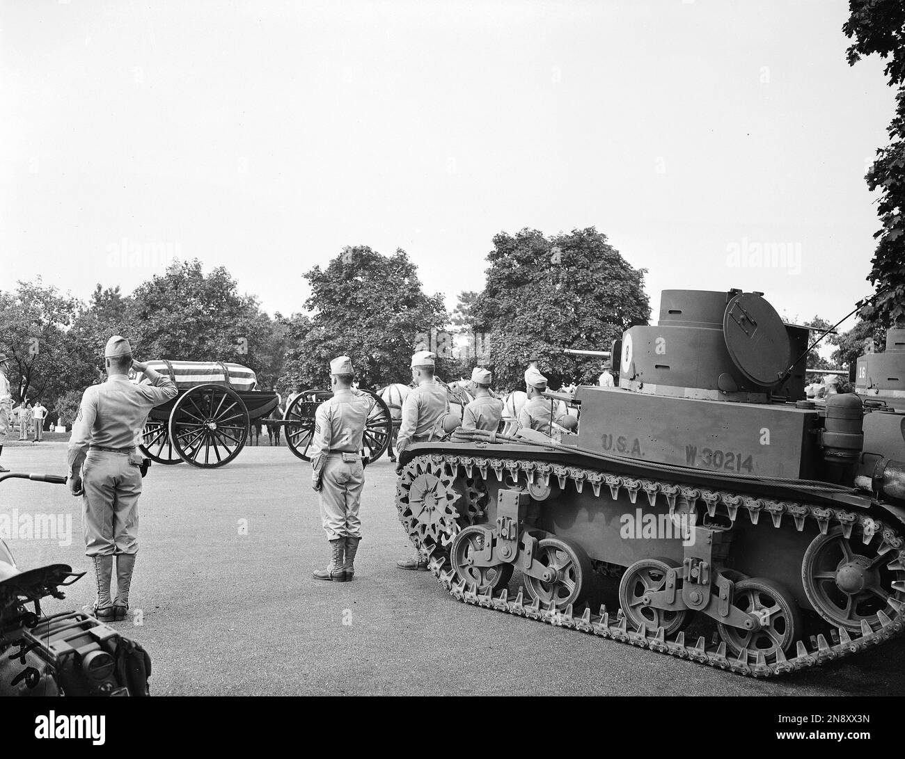 With an escorting tank unit at attention, a caisson bearing the body of ...