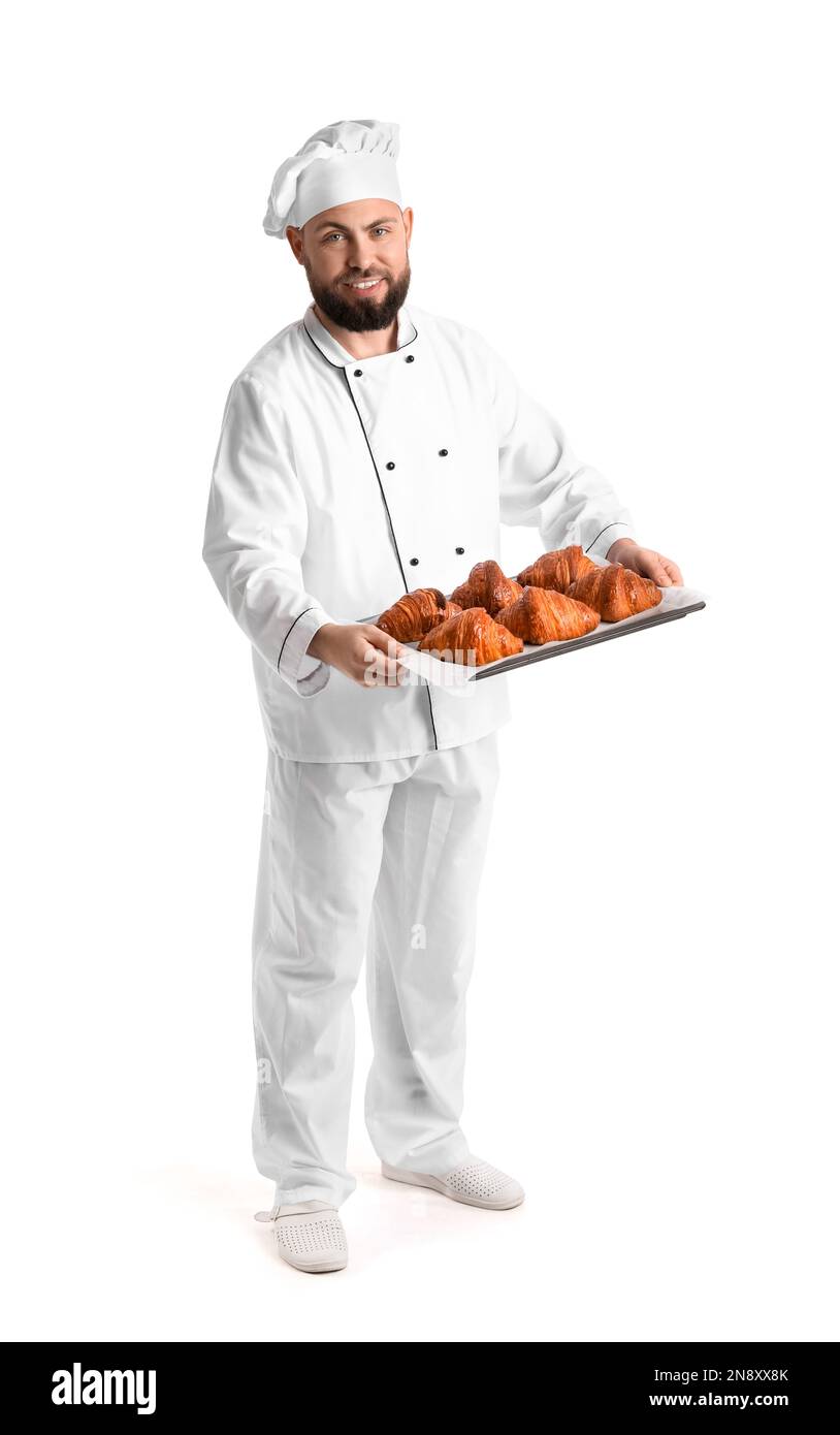 Male baker with tray of tasty croissants on white background Stock ...