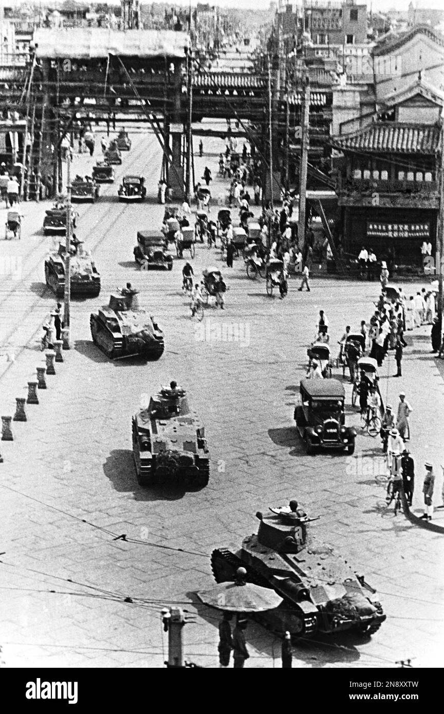 Chinese population on bicycles and in rickshaws watch Japanese tanks ...