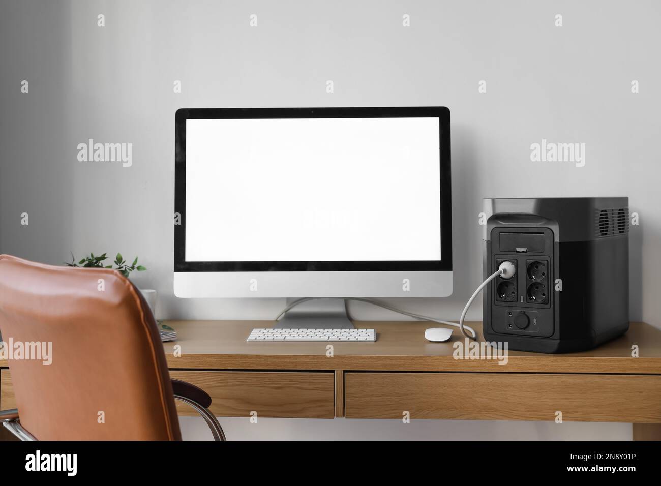 Workplace with computer and portable power station in office Stock ...