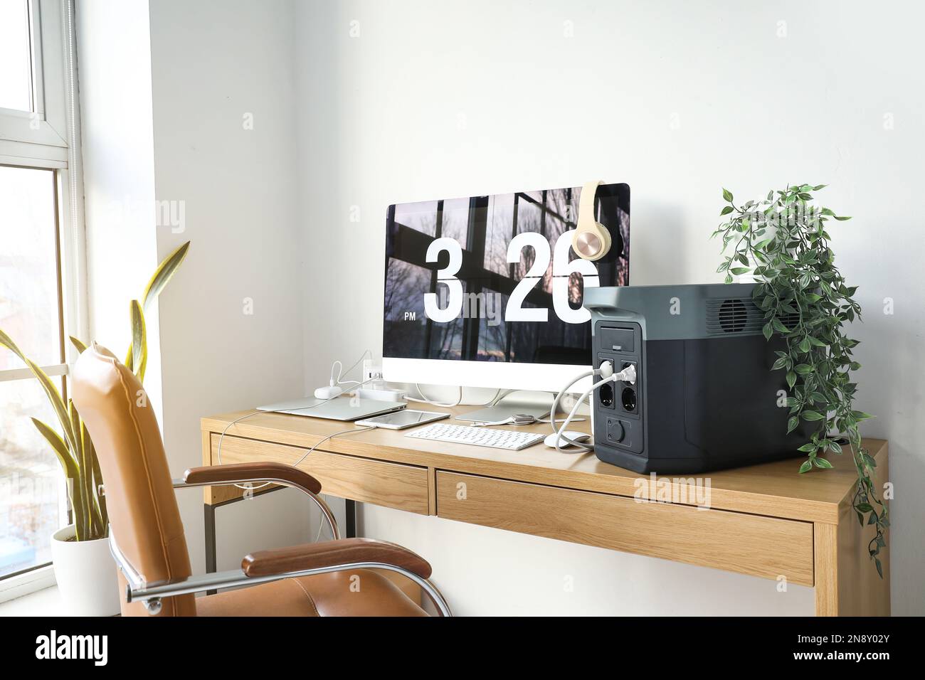 Workplace with computer and portable power station in office Stock ...